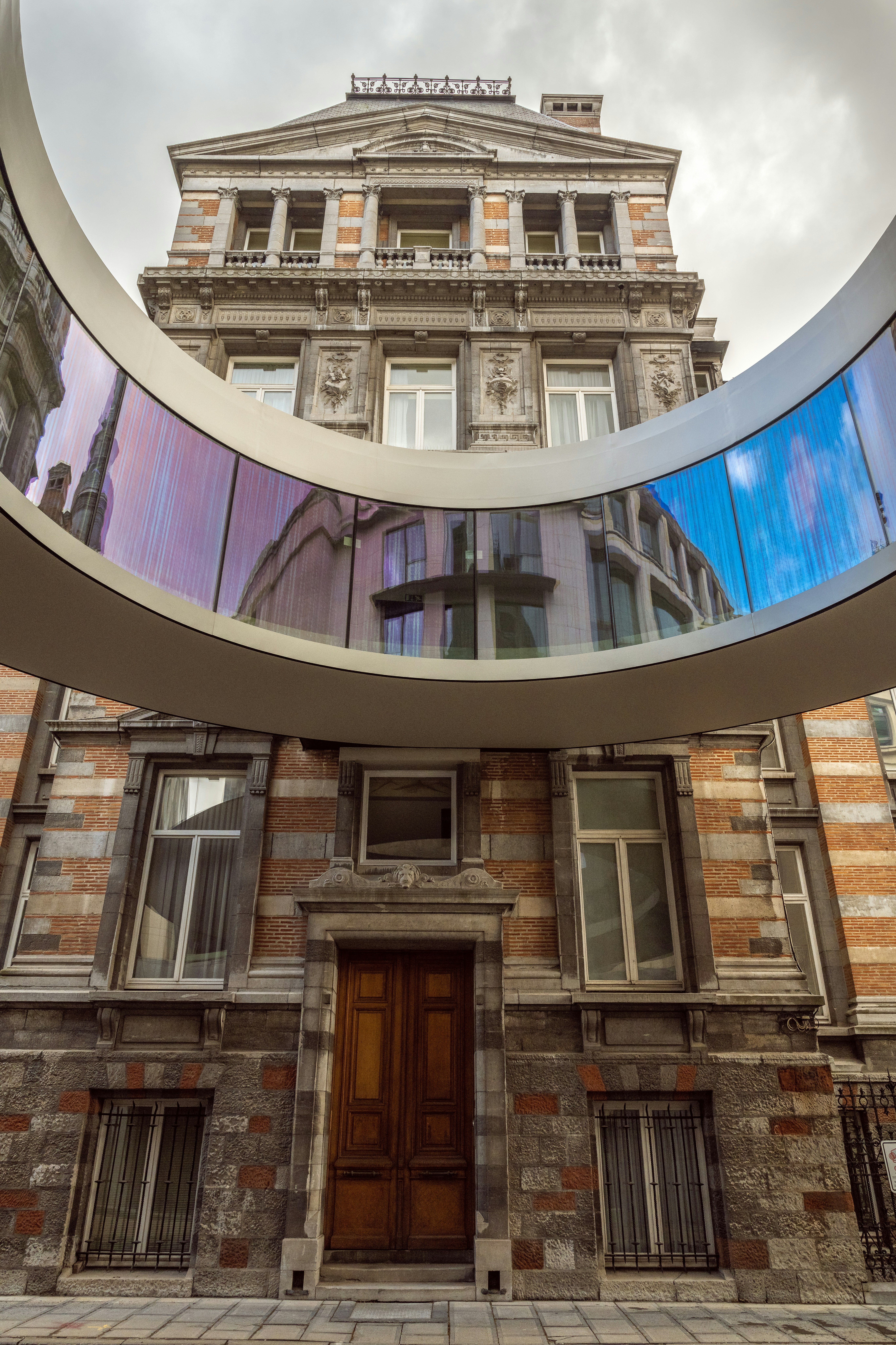 Circular Window, Historic Facade: A Modern Mindset Meets Vintage Brick