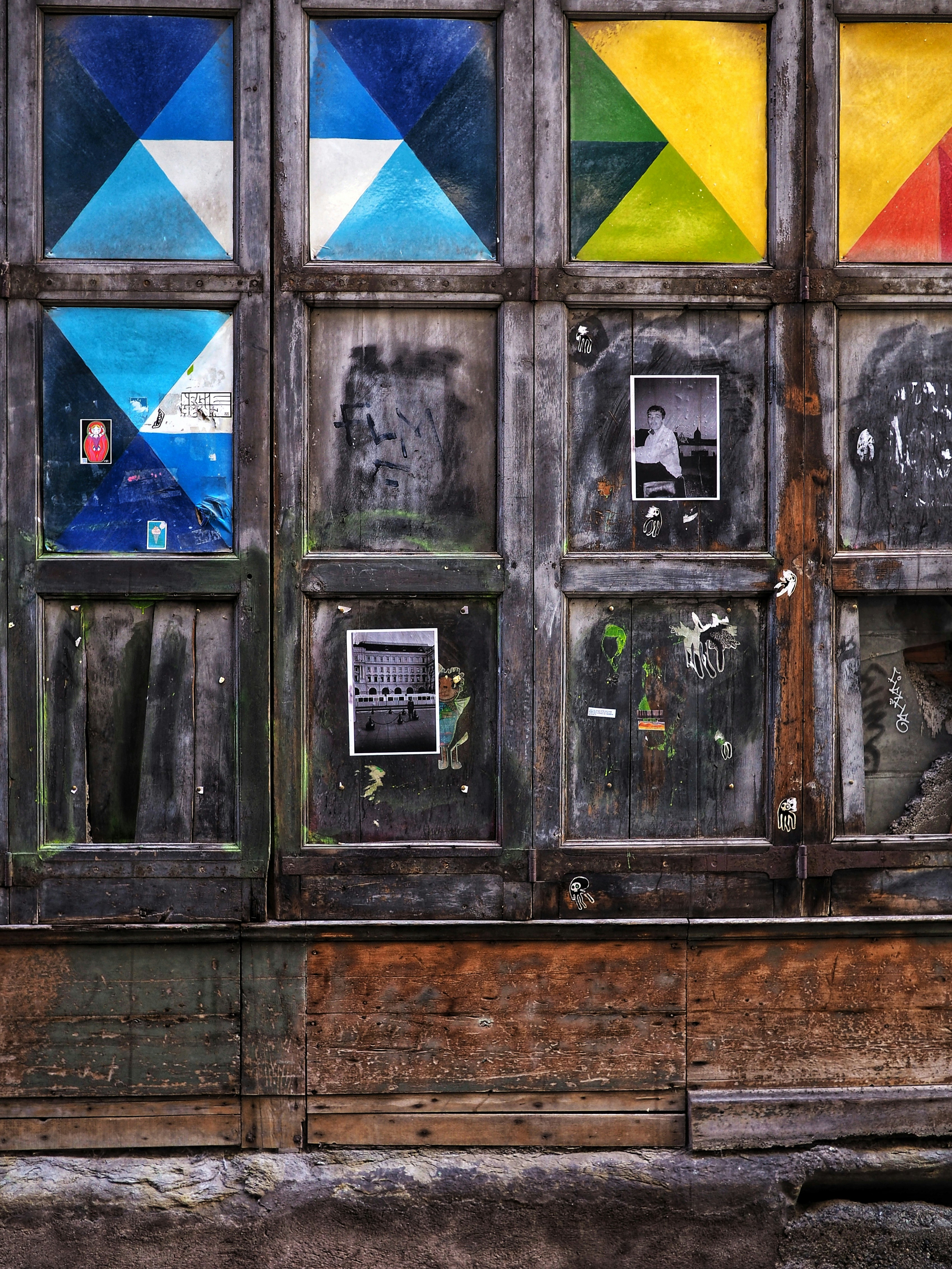 Fragmented Panels: Color Blocks and Street-Wale Graffiti on a Weathered Door