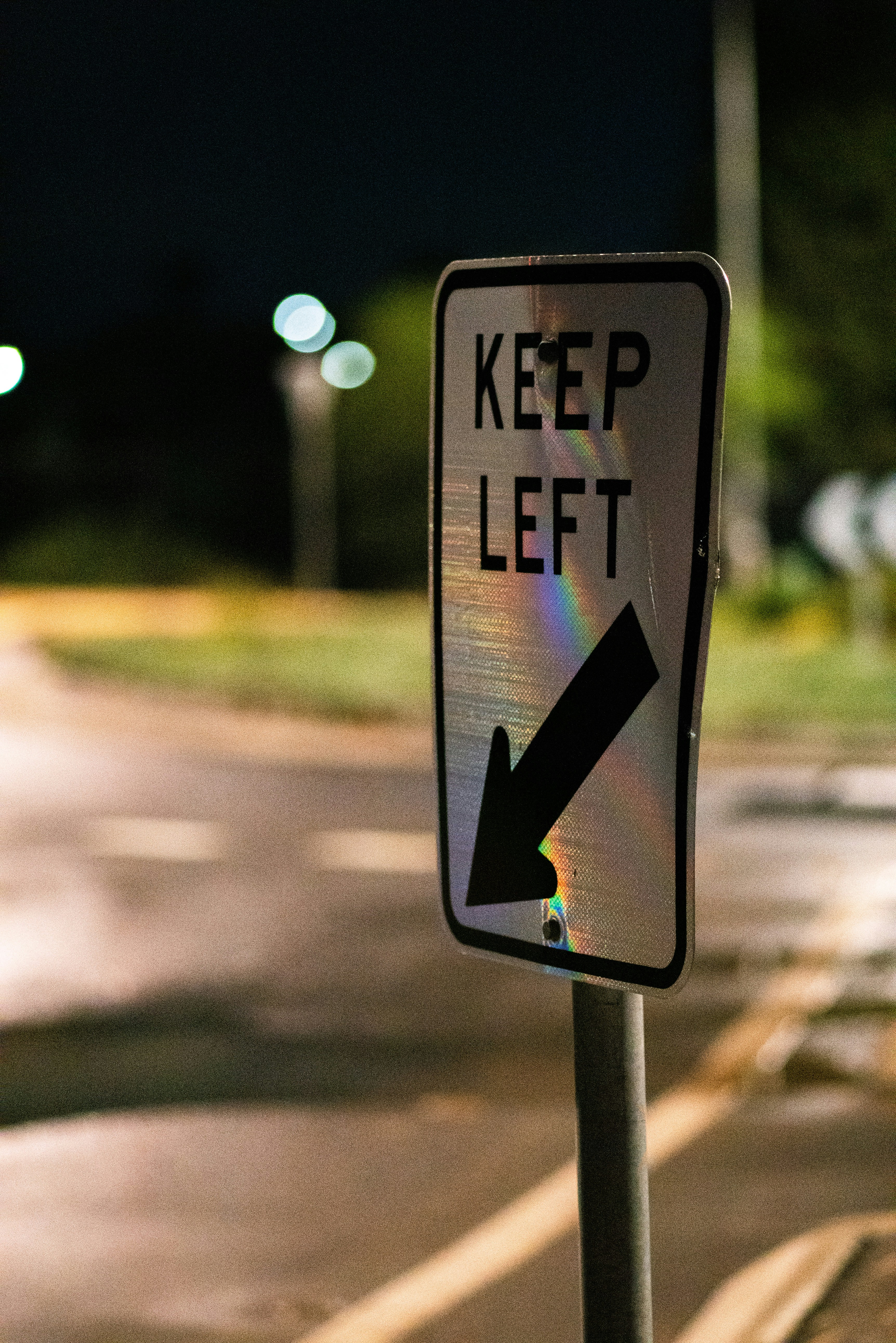 A keep left sign on the side of the road photo – Free Symbol Image on ...
