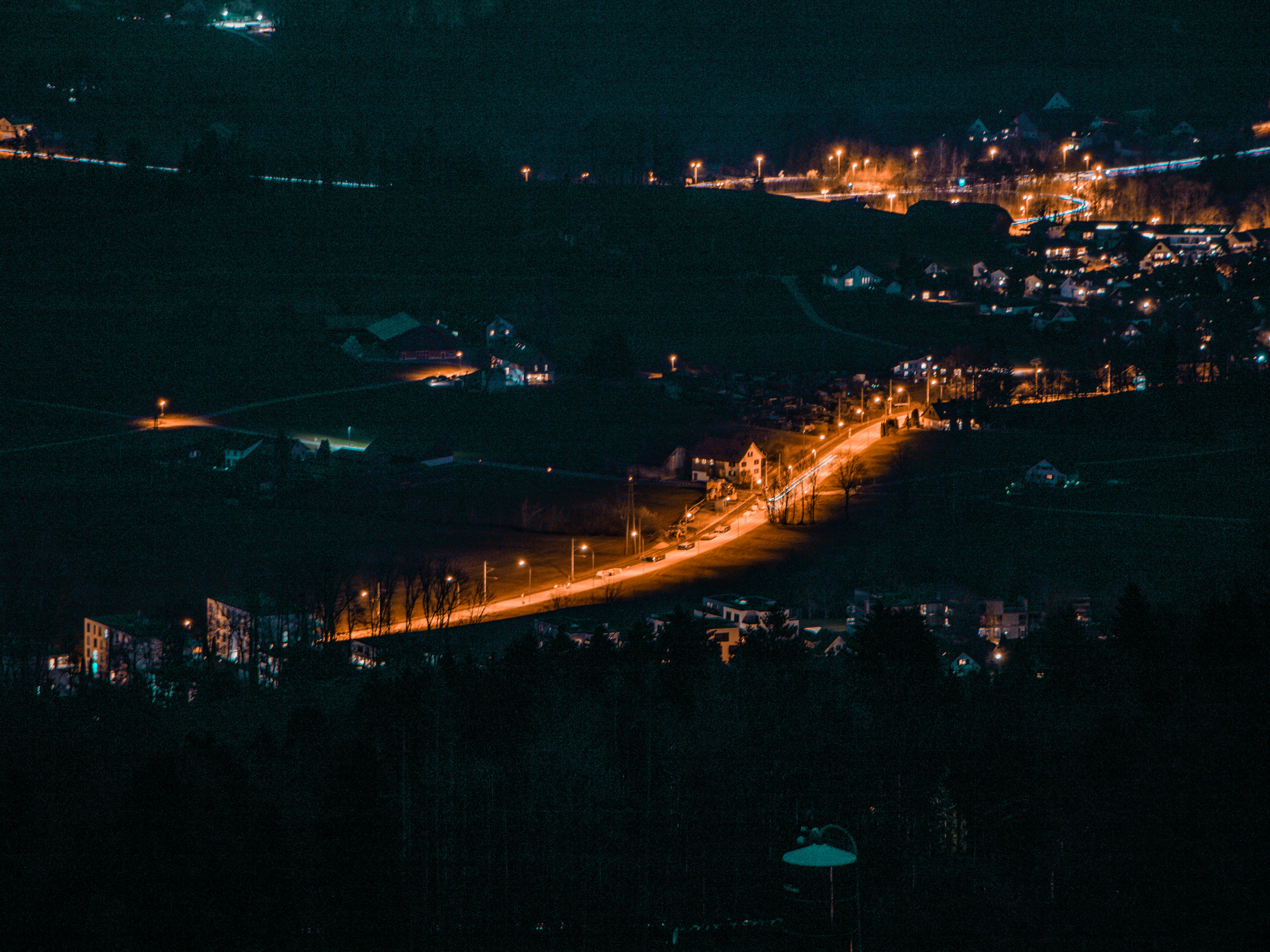 Amber Thread Along a Hilltown's Night Road