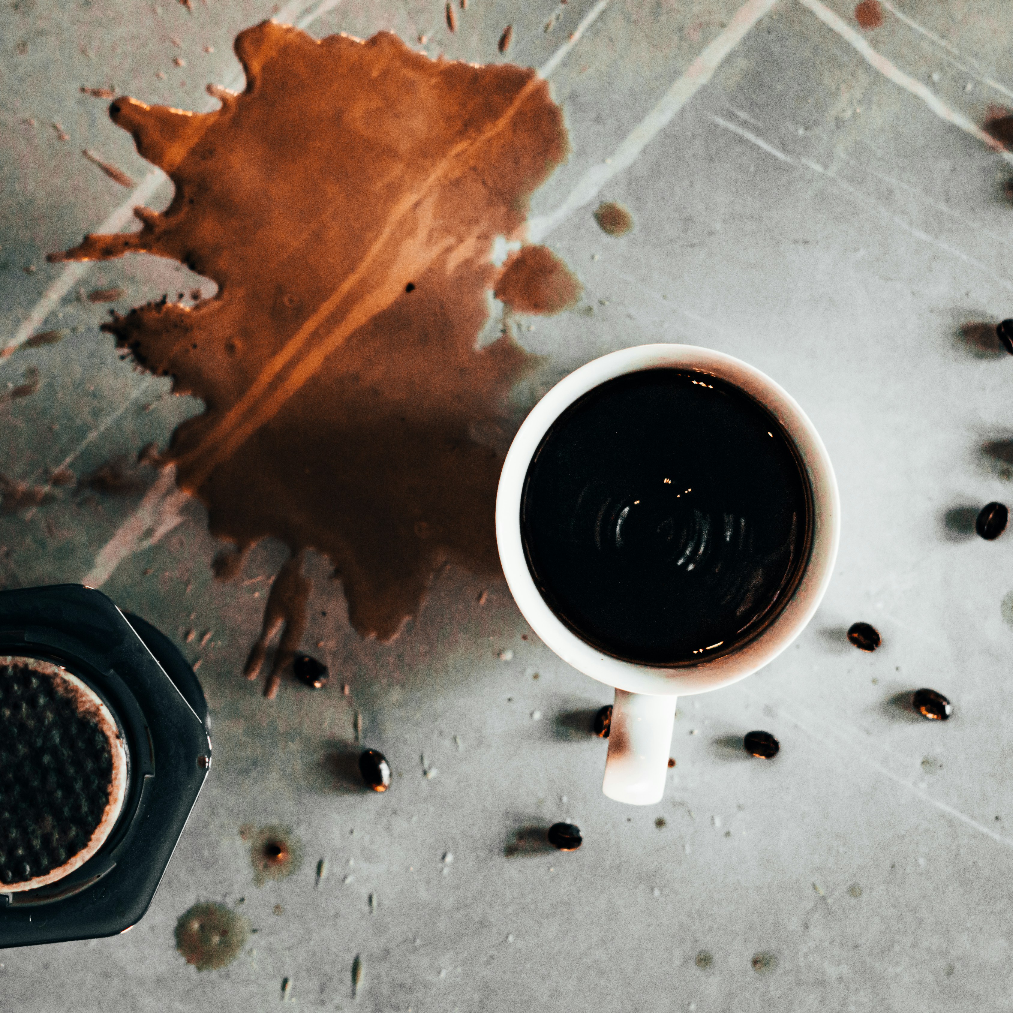 Coffee Spill Over Concrete: A Top-Down Moment of Quiet Caffeine