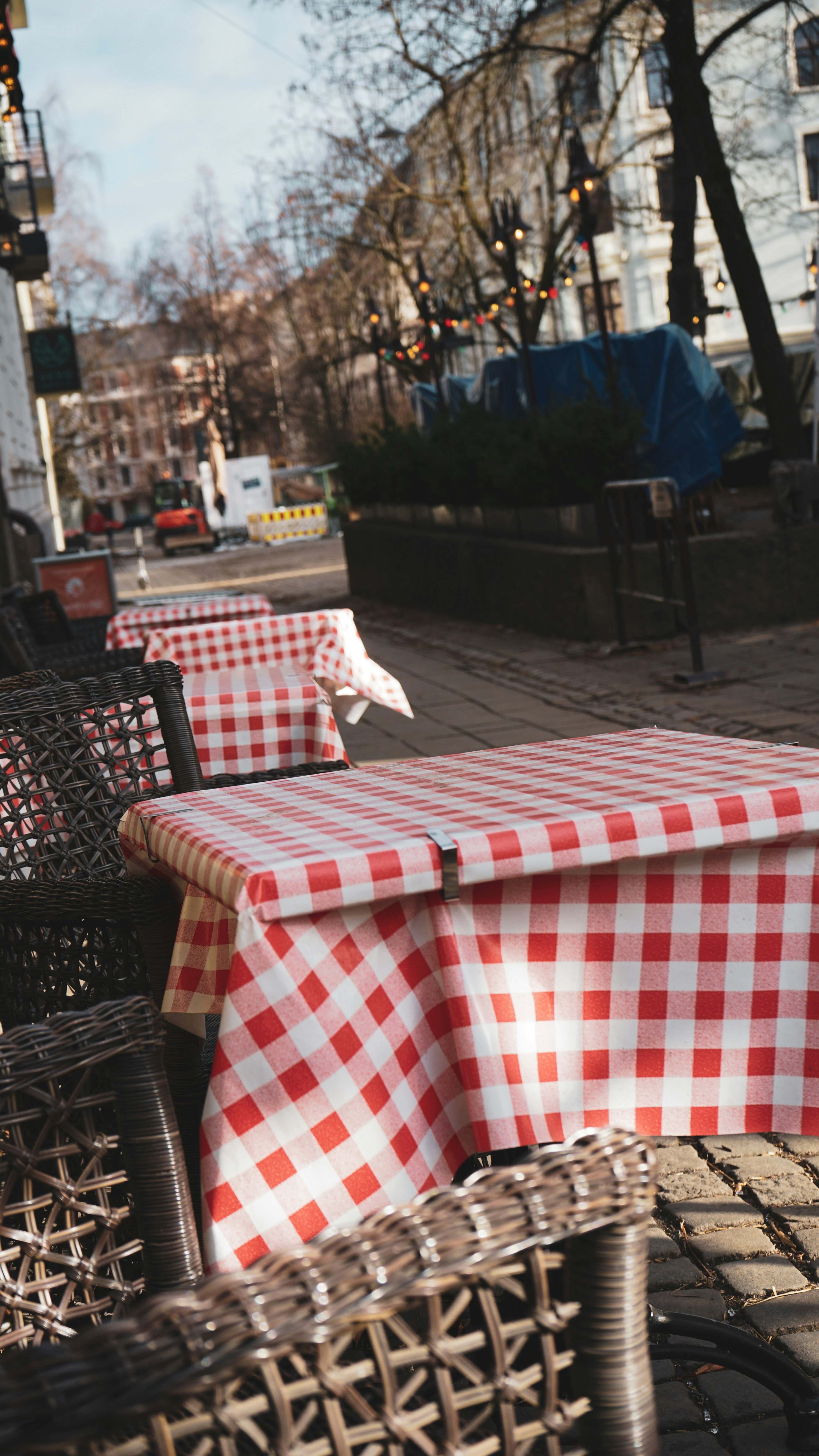Checkerboard Tables on a Cobblestone Street: A Quiet Street Café Moment