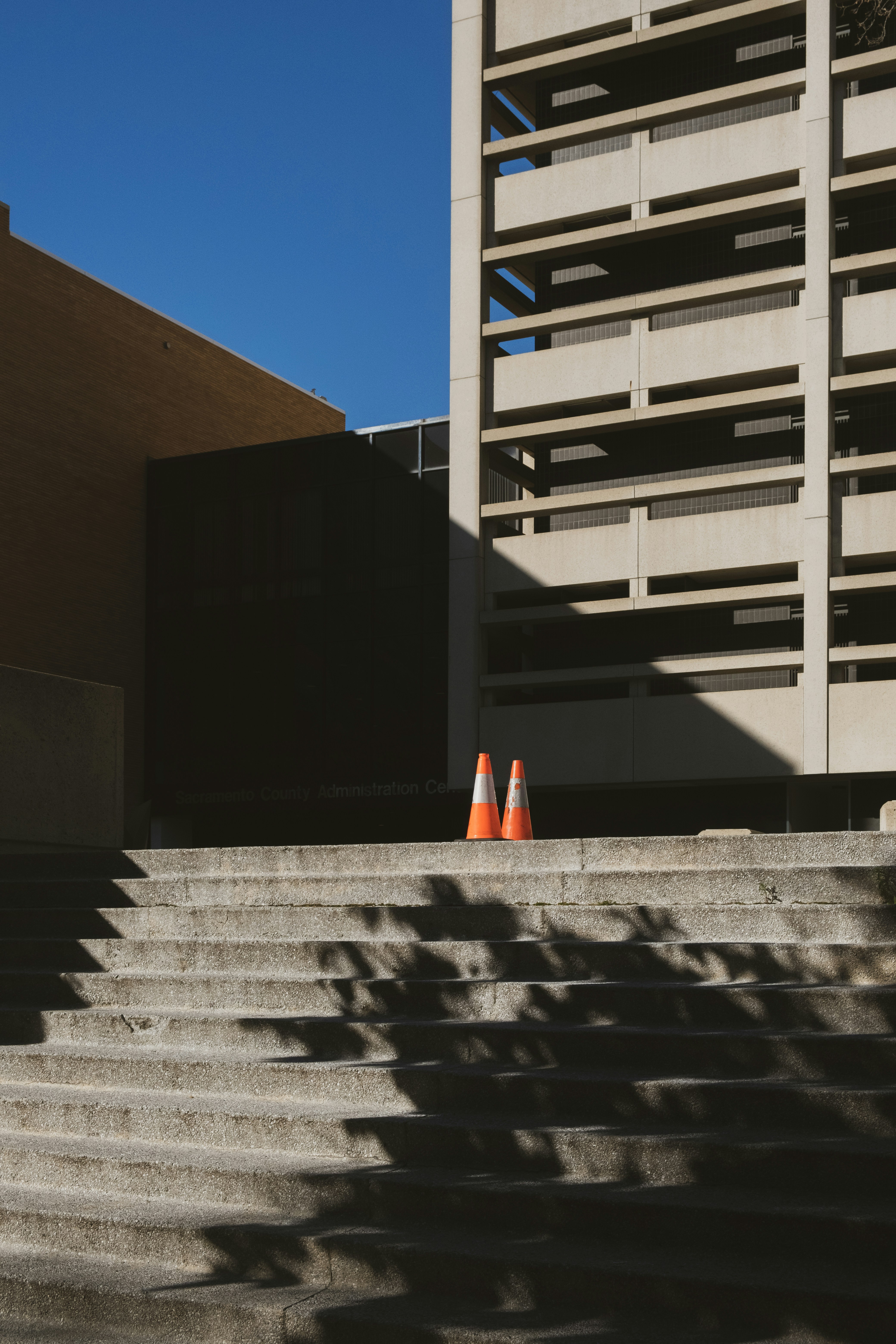 Orange traffic cone on gray concrete stairs photo – Free Building Image ...