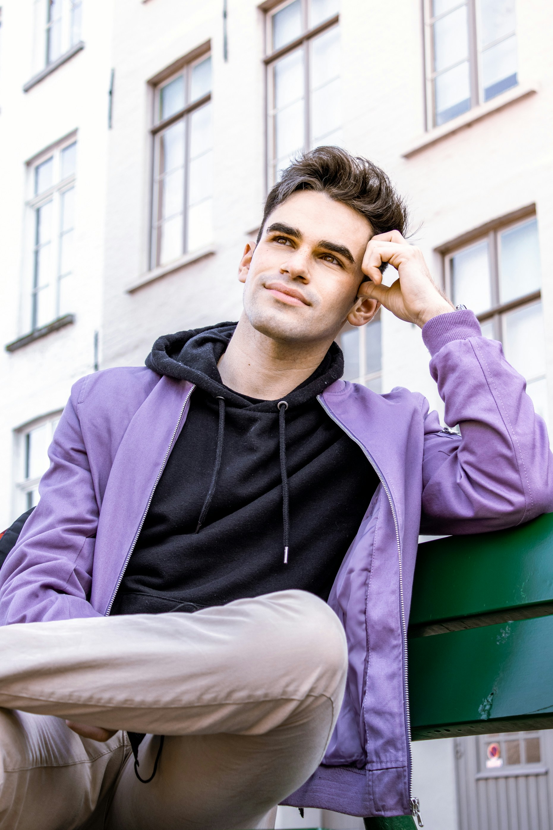 City Silence in Violet: A Portrait on a Green Bench