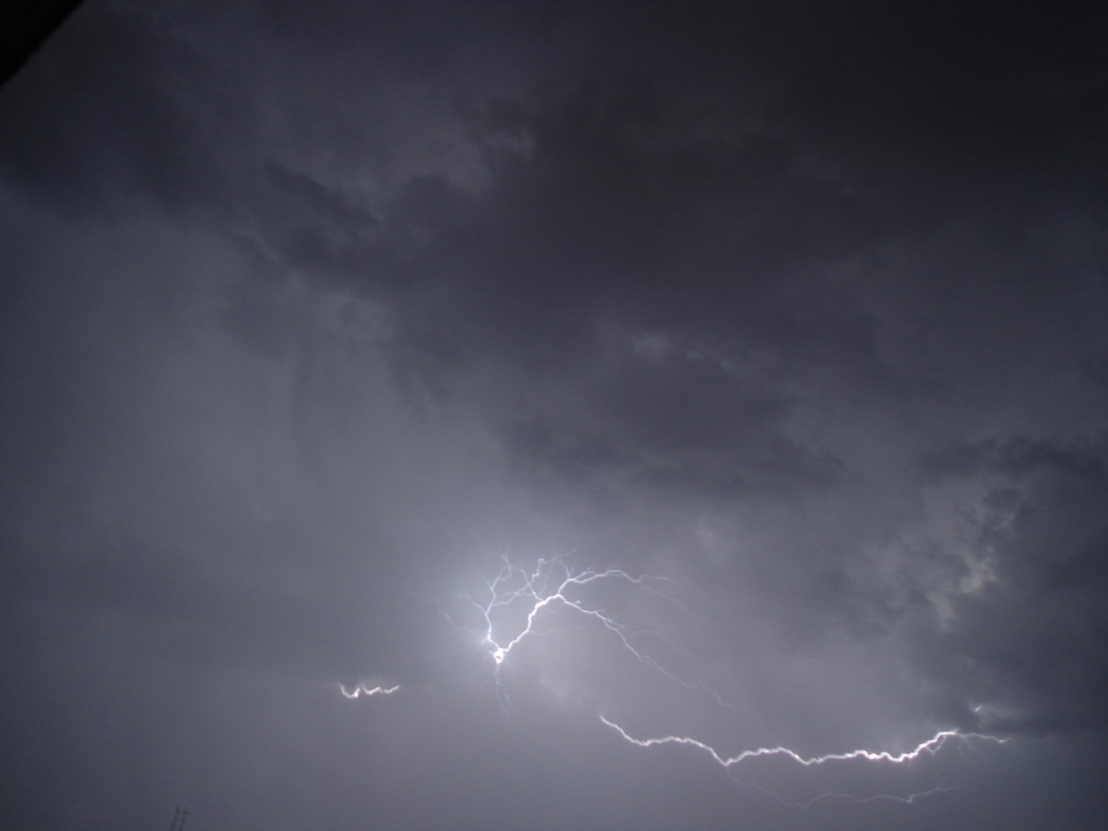 Lightning illuminating dark storm clouds during a thunderstorm.