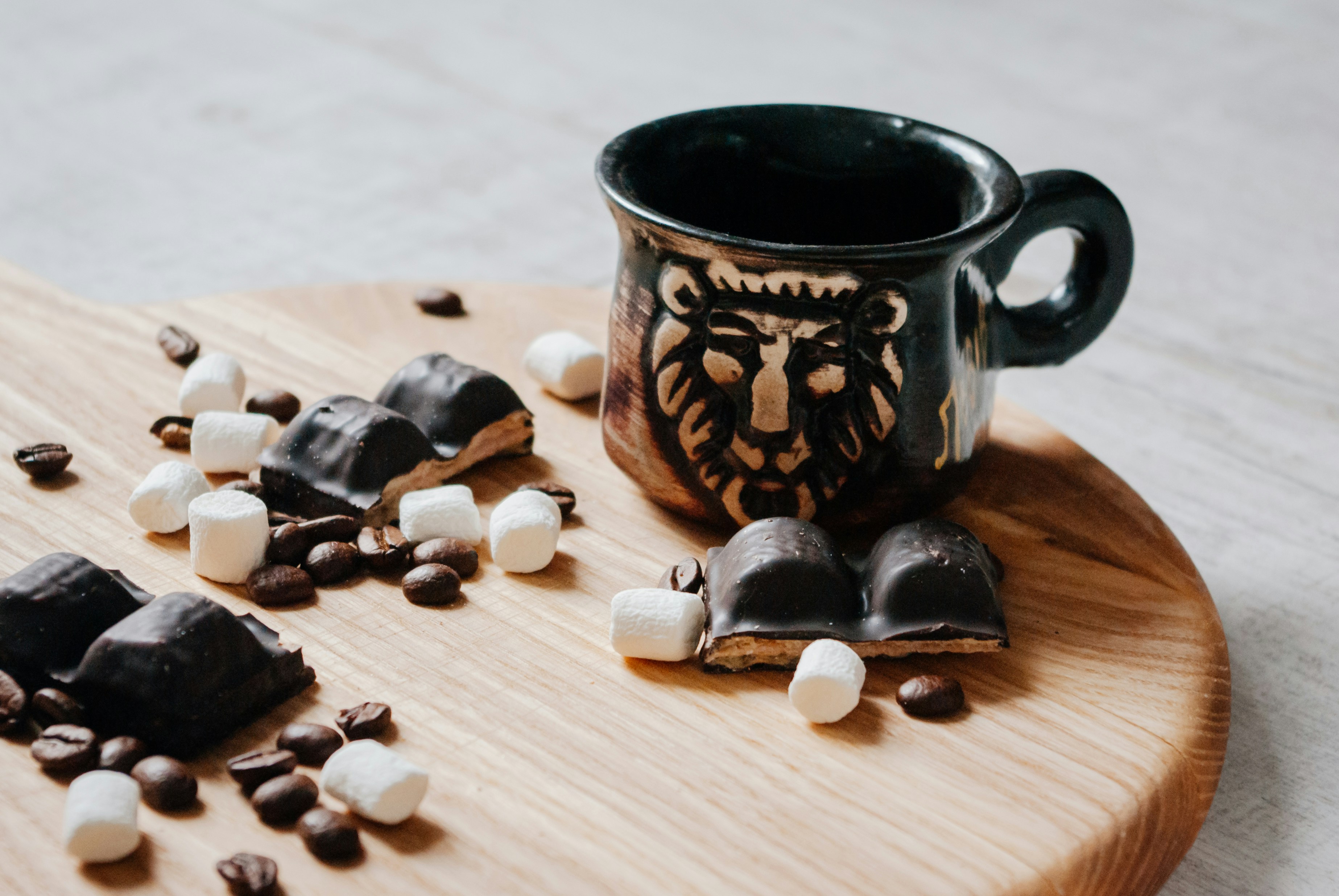 Tiger mug and cocoa morsels on a wooden board