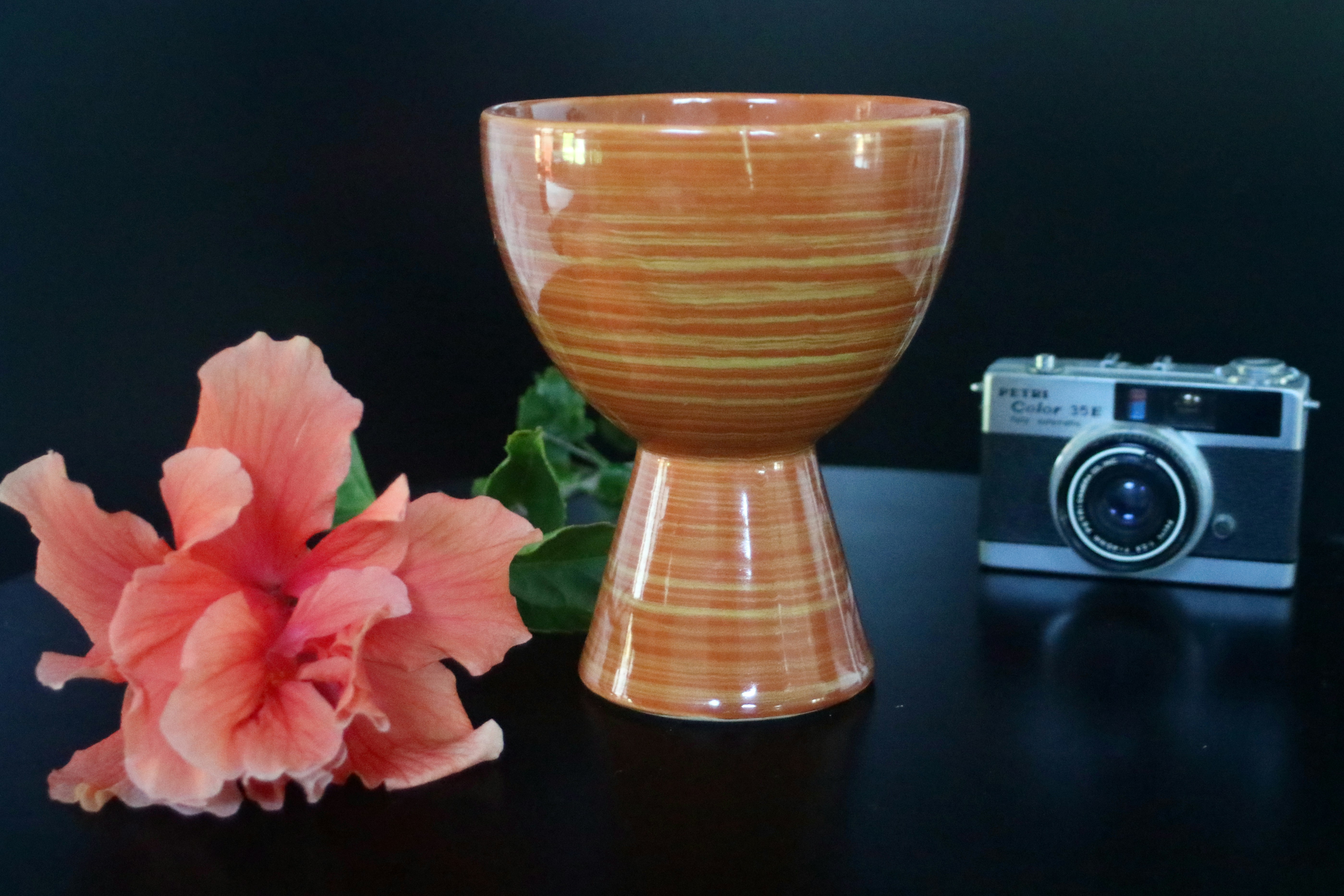 Centerstage Goblet: A Wooden Vessel Framed by Hibiscus and a Vintage Camera