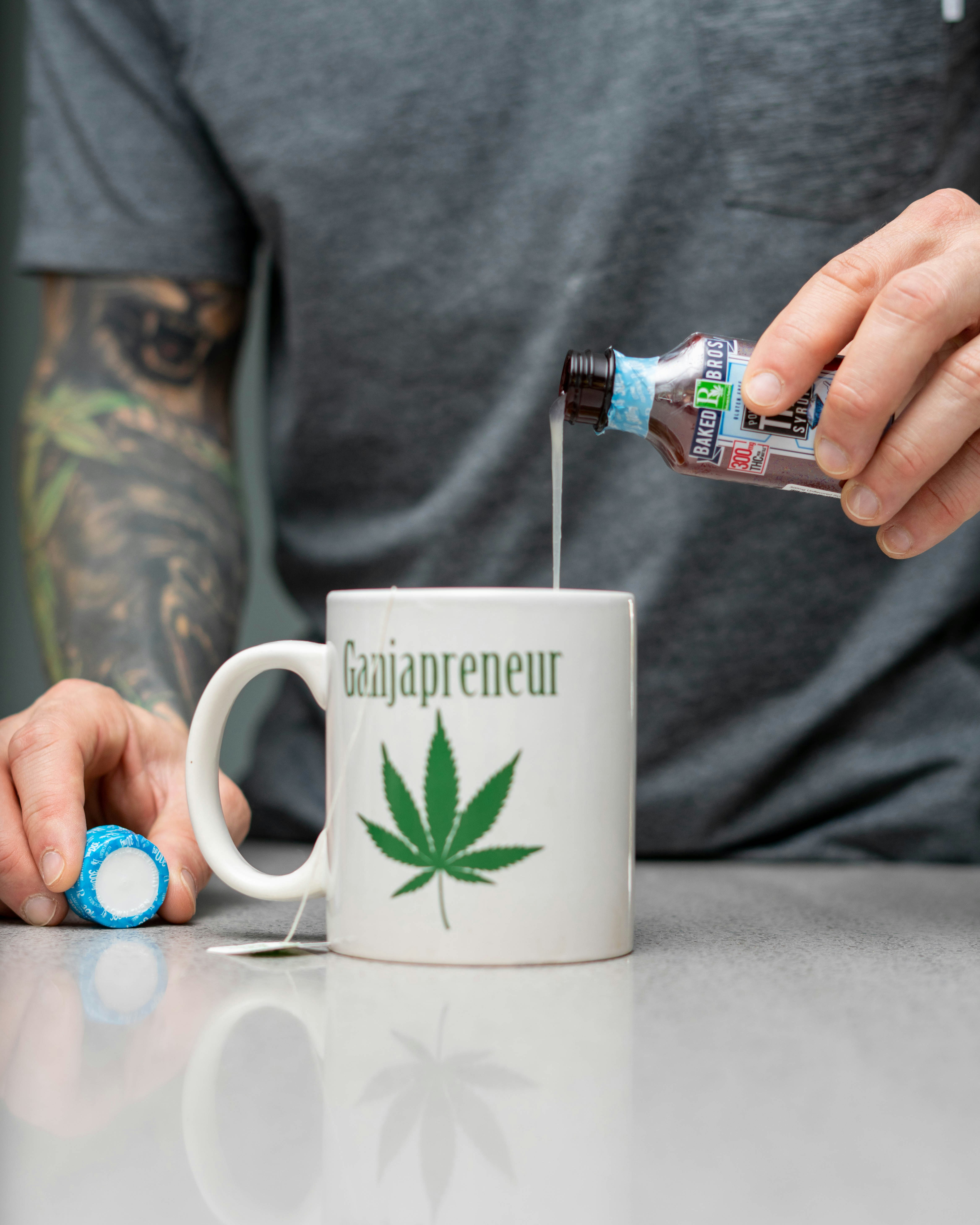 Pouring Clarity: A Ganjapreneur Mug Framed by a Cannabis Leaf