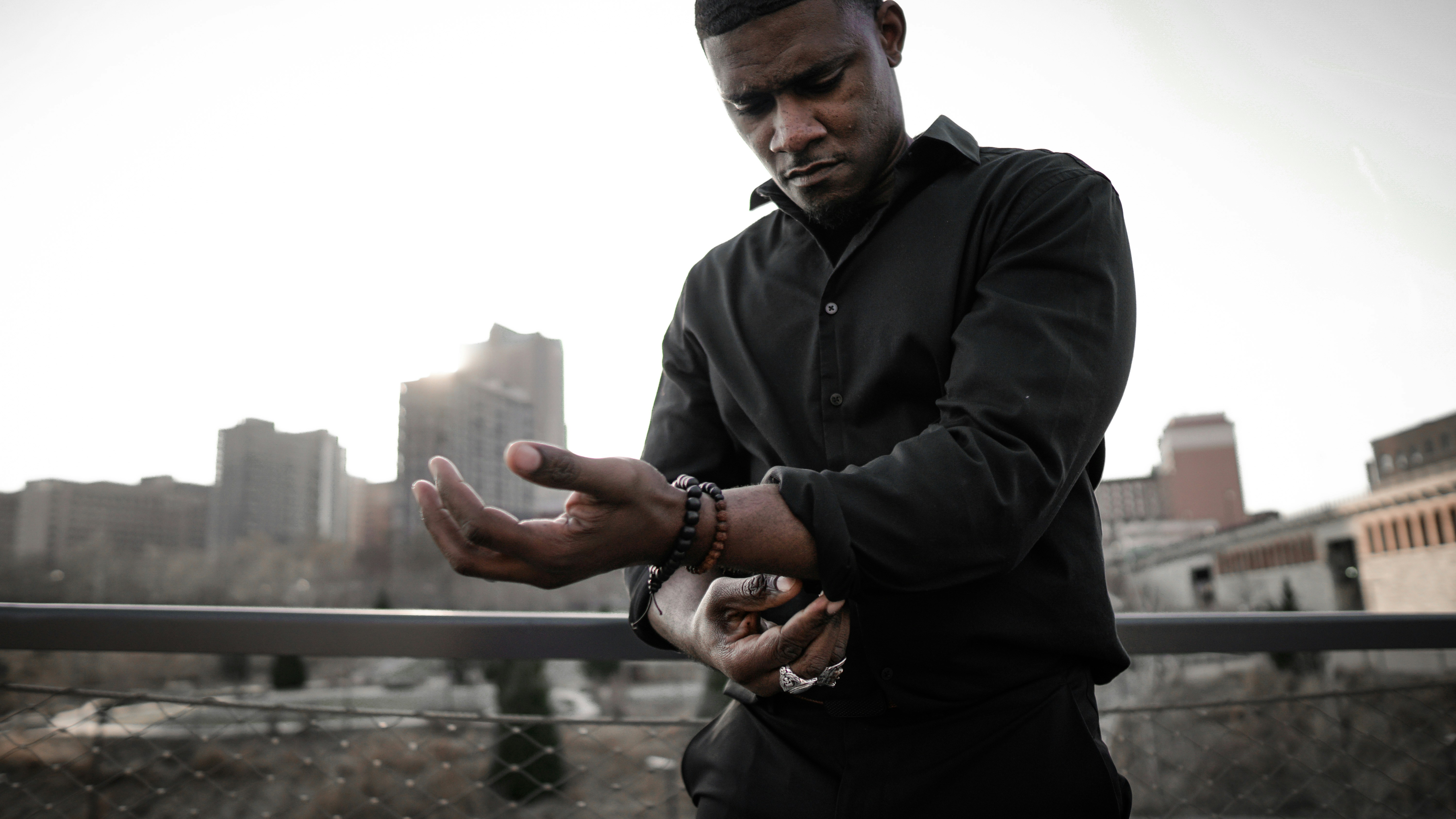 Hands in Focus: A Quiet Moment on the Rooftop