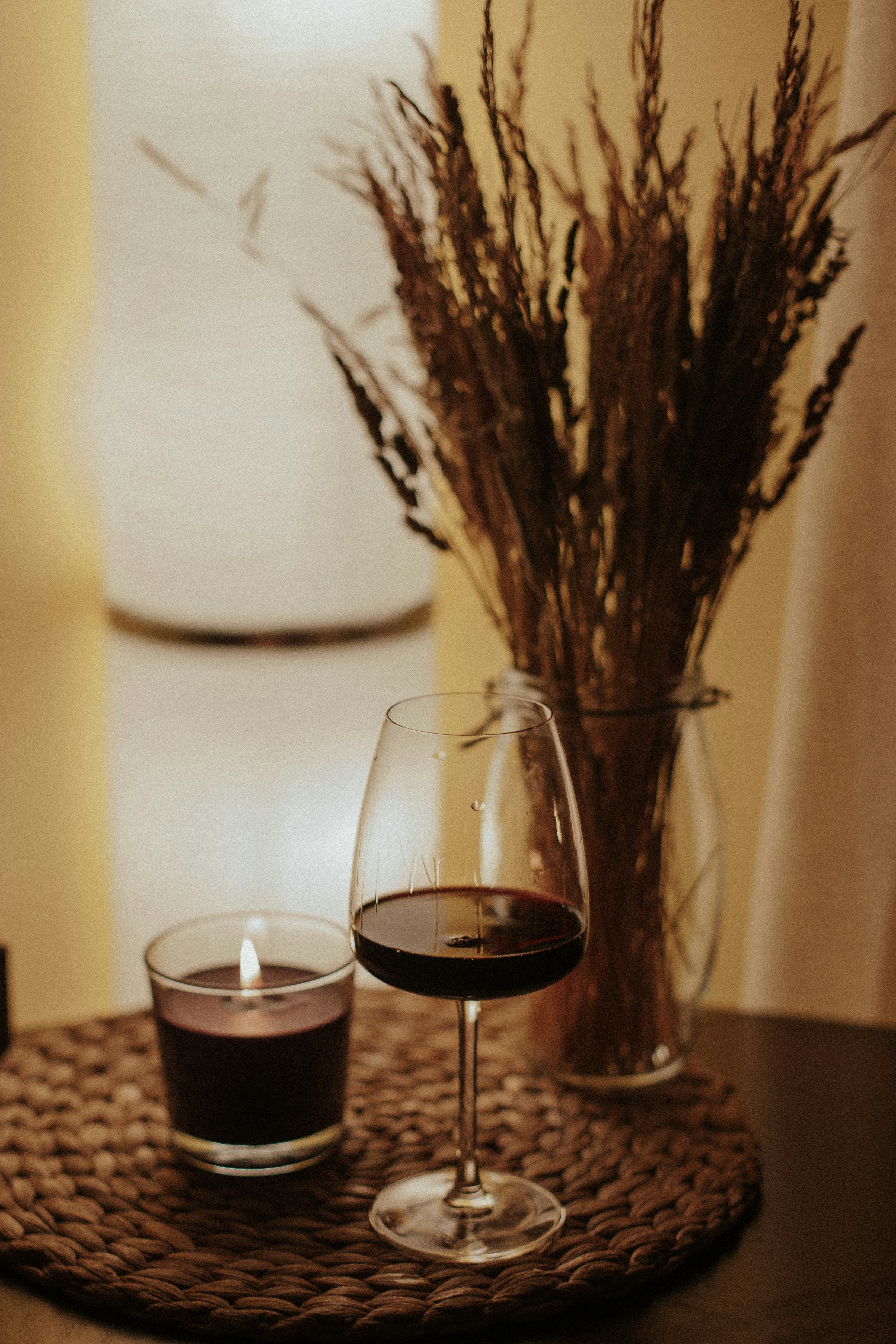 Amber Quiet: Red Wine, Candle, and Rustic Tall Grass Still Life