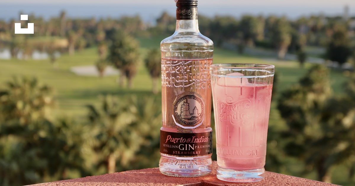 Clear Glass Bottle Beside Clear Drinking Glass On Brown Wooden Table Photo Free Gin Image On