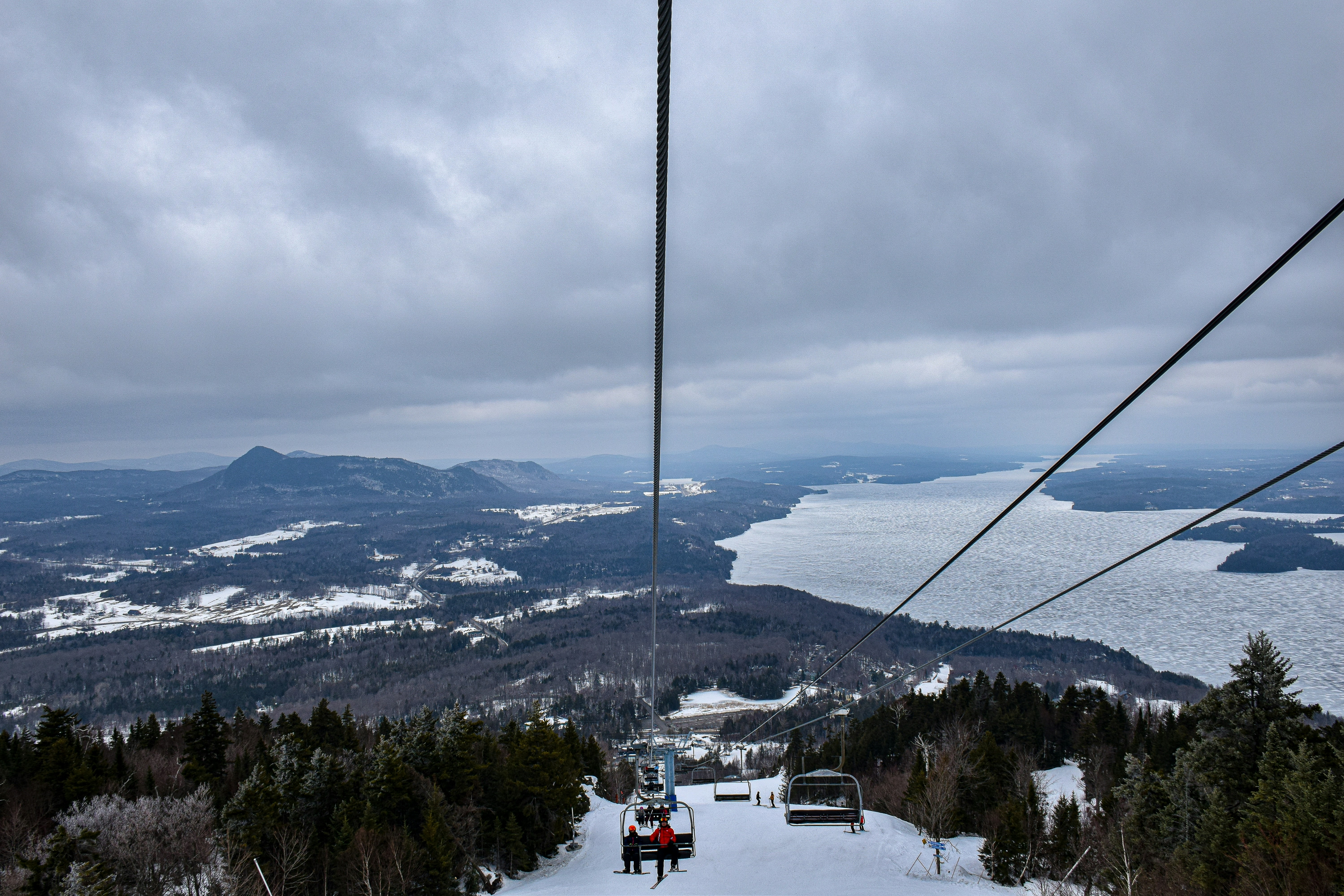 Gondola Over a Frosted Fjord: Snow-Covered Pines and Sky-Heavy Horizon