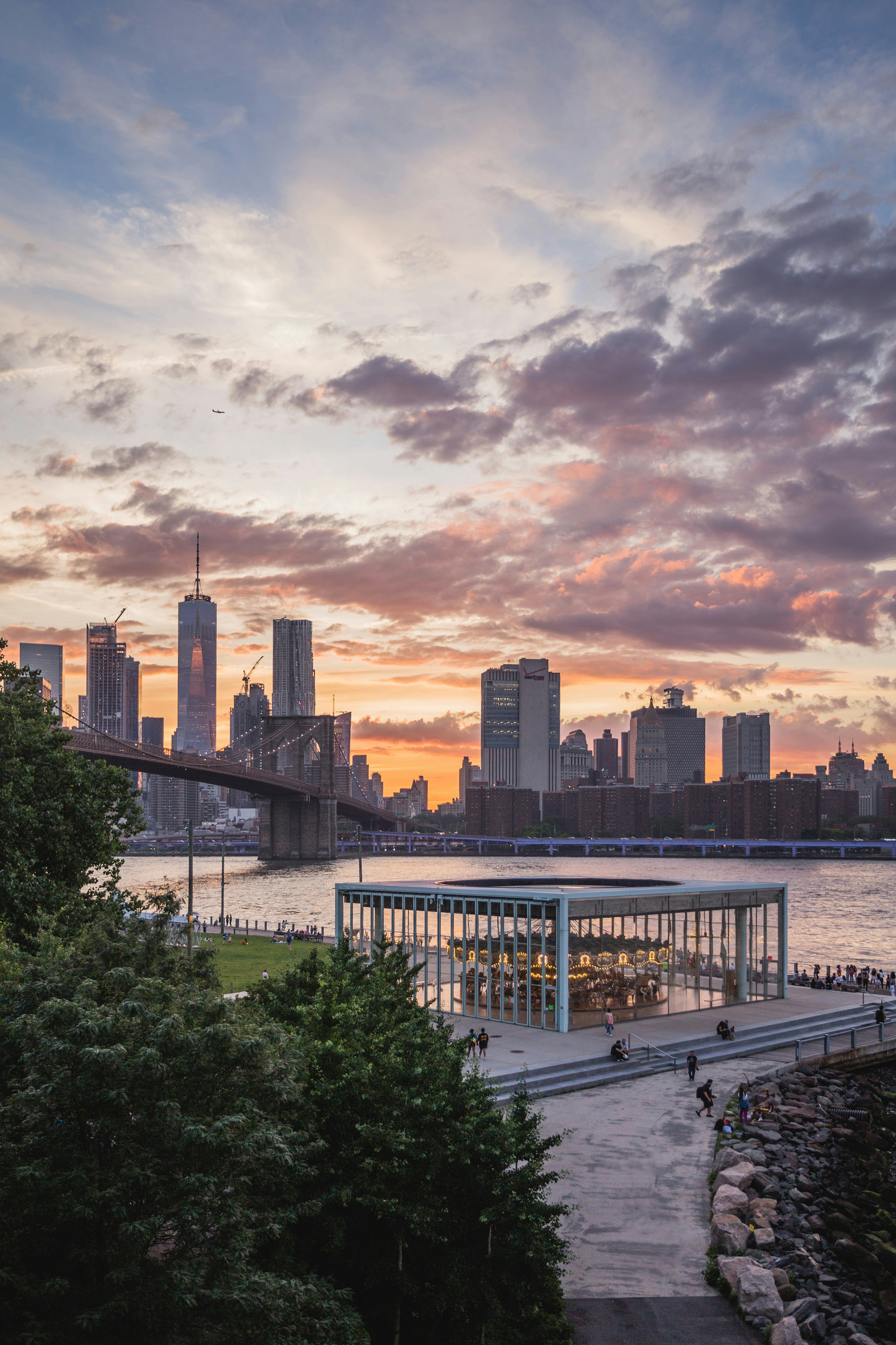 Glass Pavilion at Dusk: Riverside Geometry Framing a Skyline