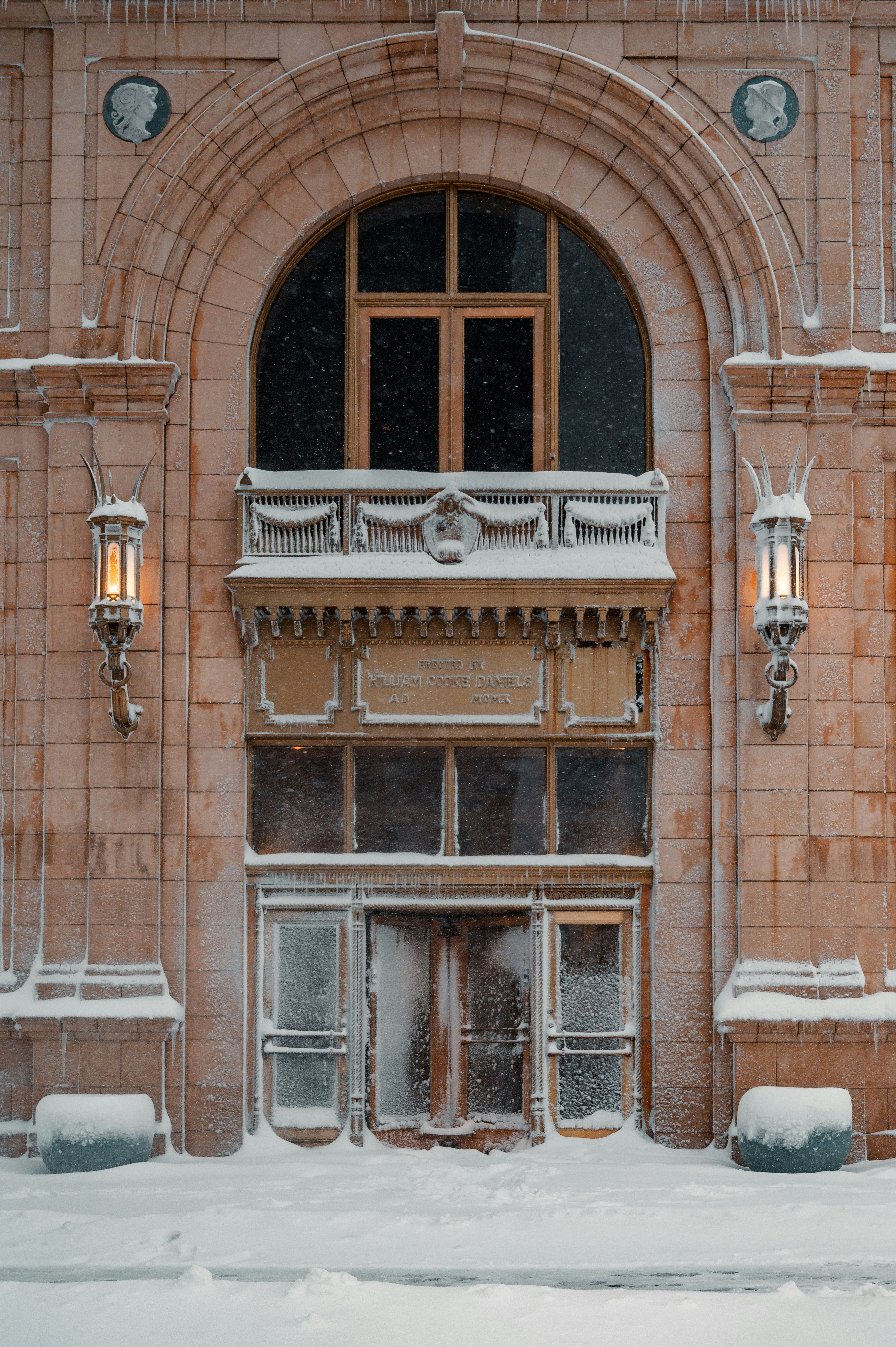 Snow-veiled Archway: Ornate Facade Framed by Twin Lanterns