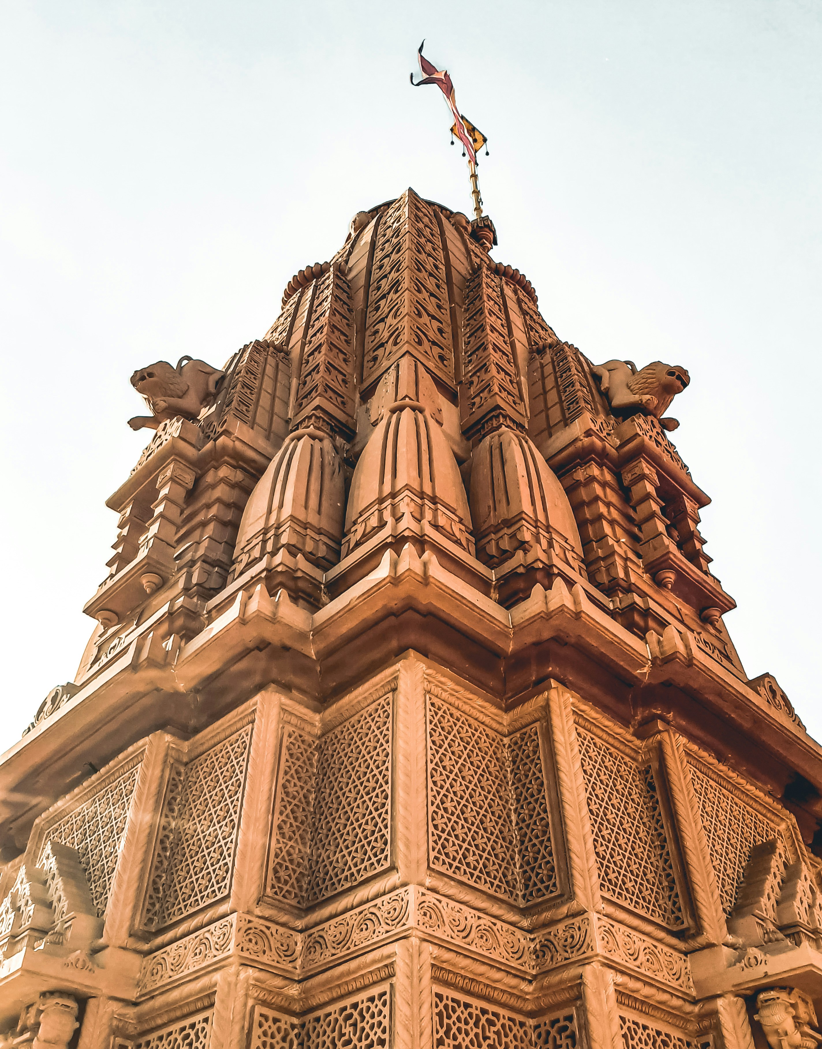 Ornate temple tower showcasing intricate carvings against a clear sky.