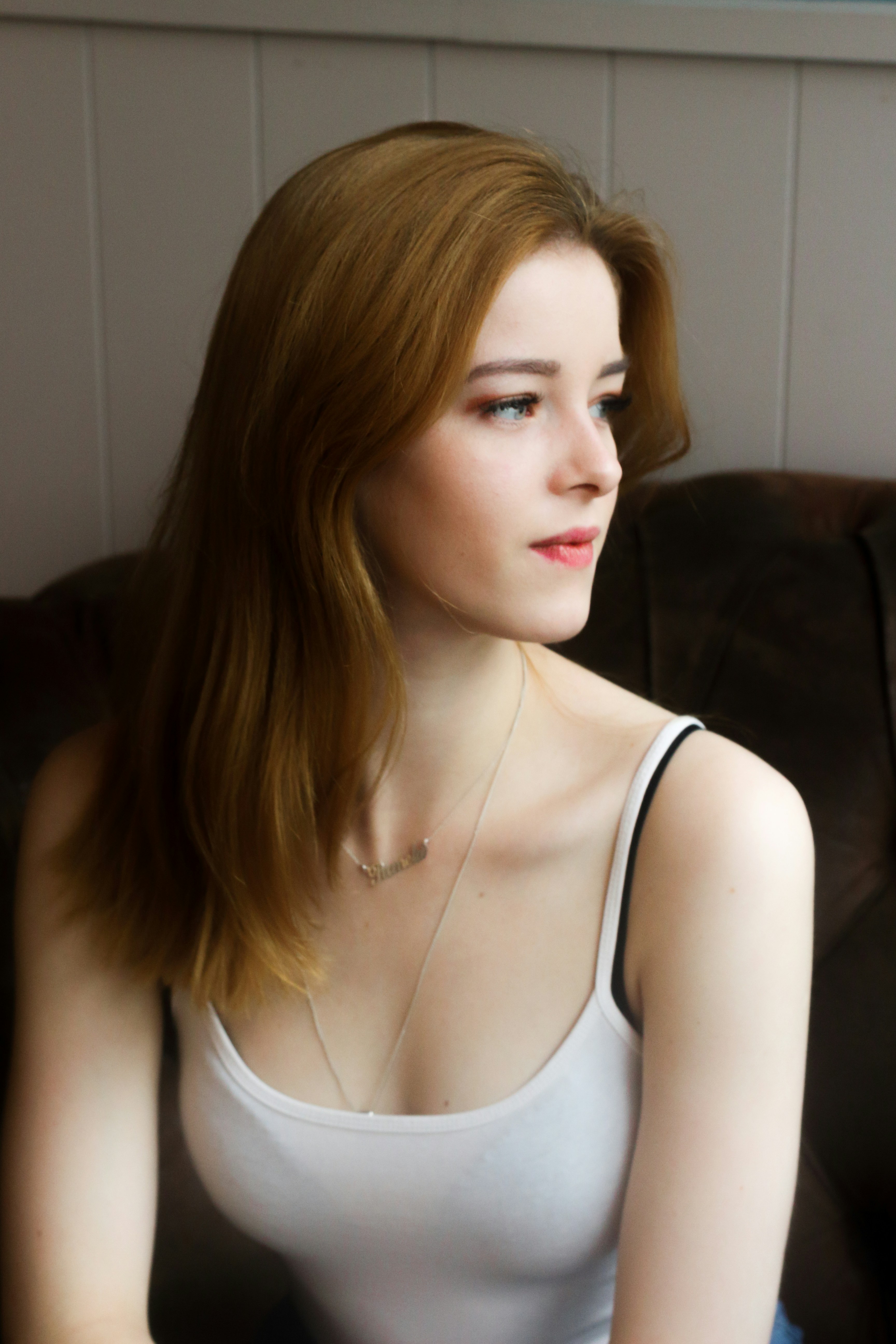 Strawberry Light: A Quiet Portrait on a Neutral Couch