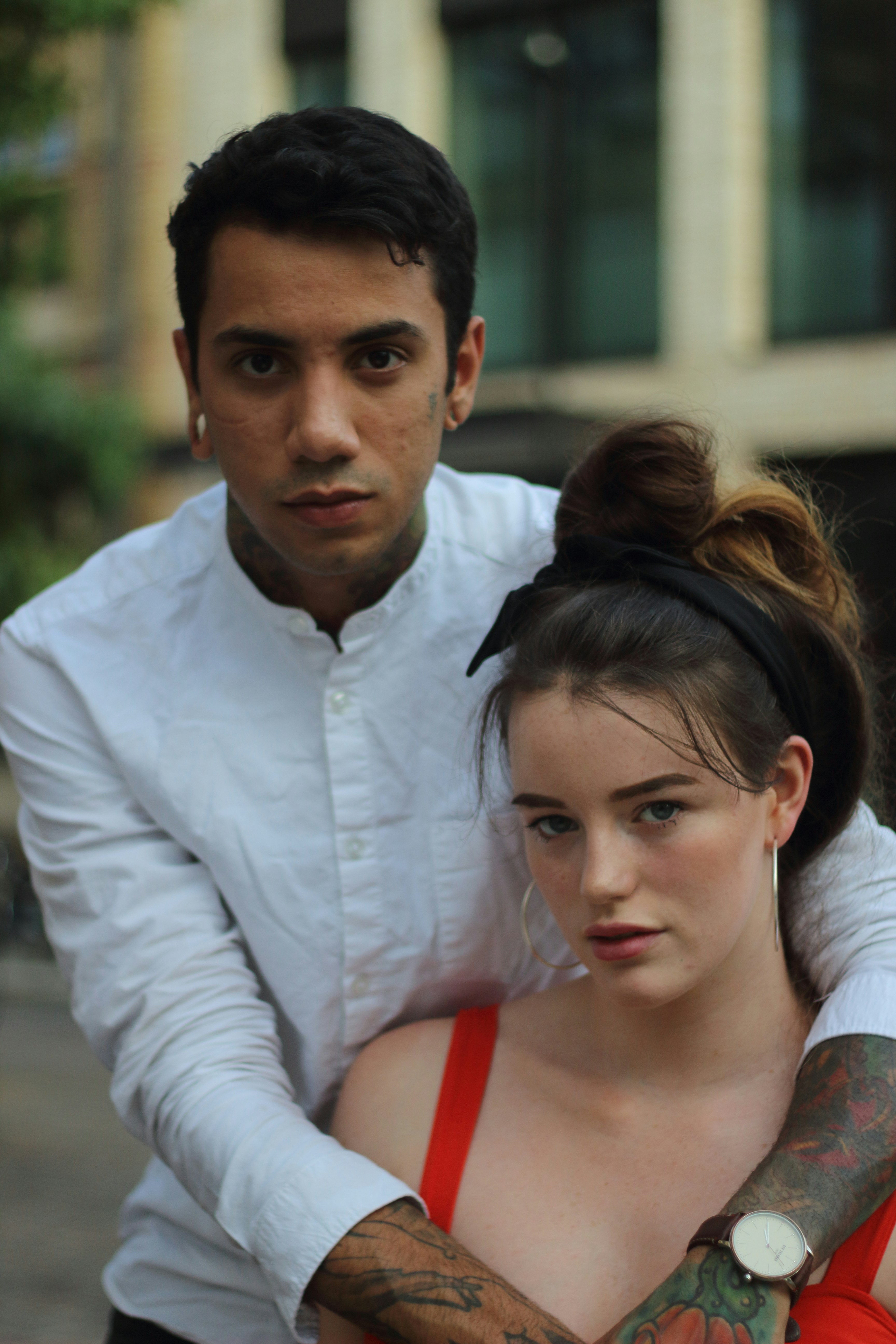 Man in white dress shirt hugging woman in red and white stripe tank top ...