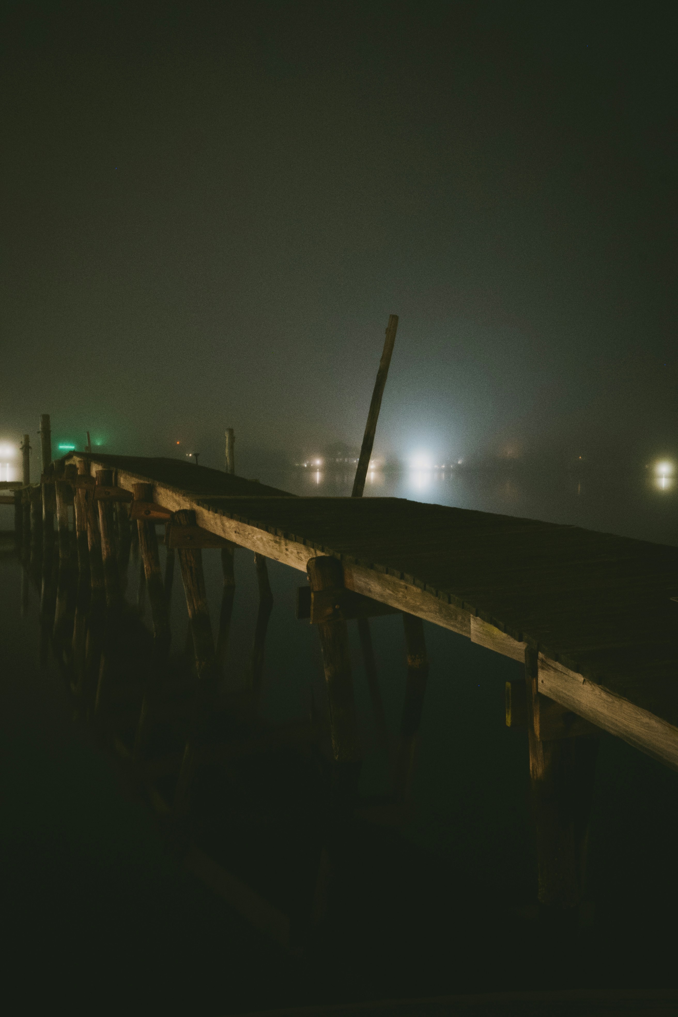 brown wooden dock on sea during night time