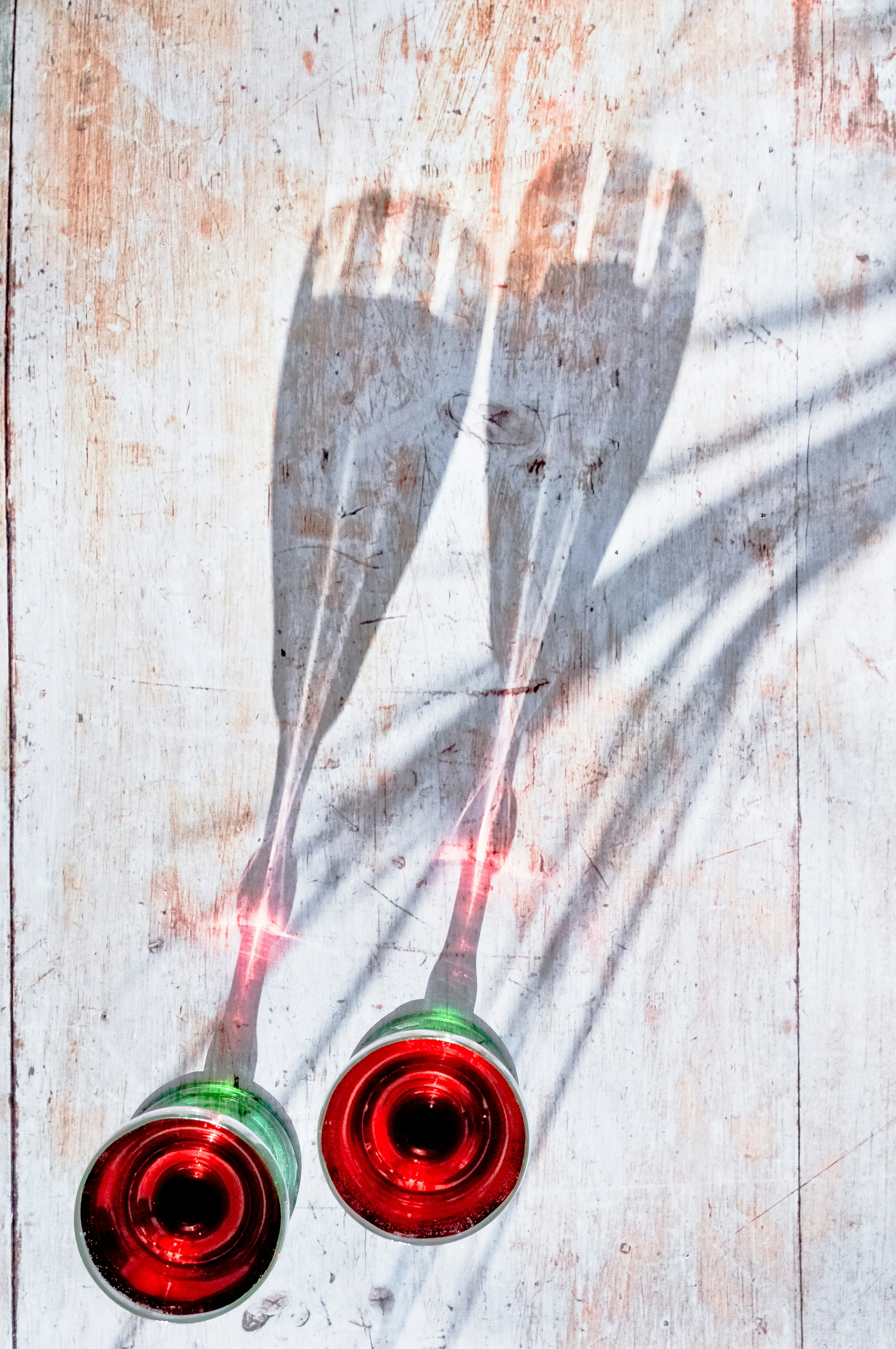 Twin Crimson Orbs on Weathered Wood