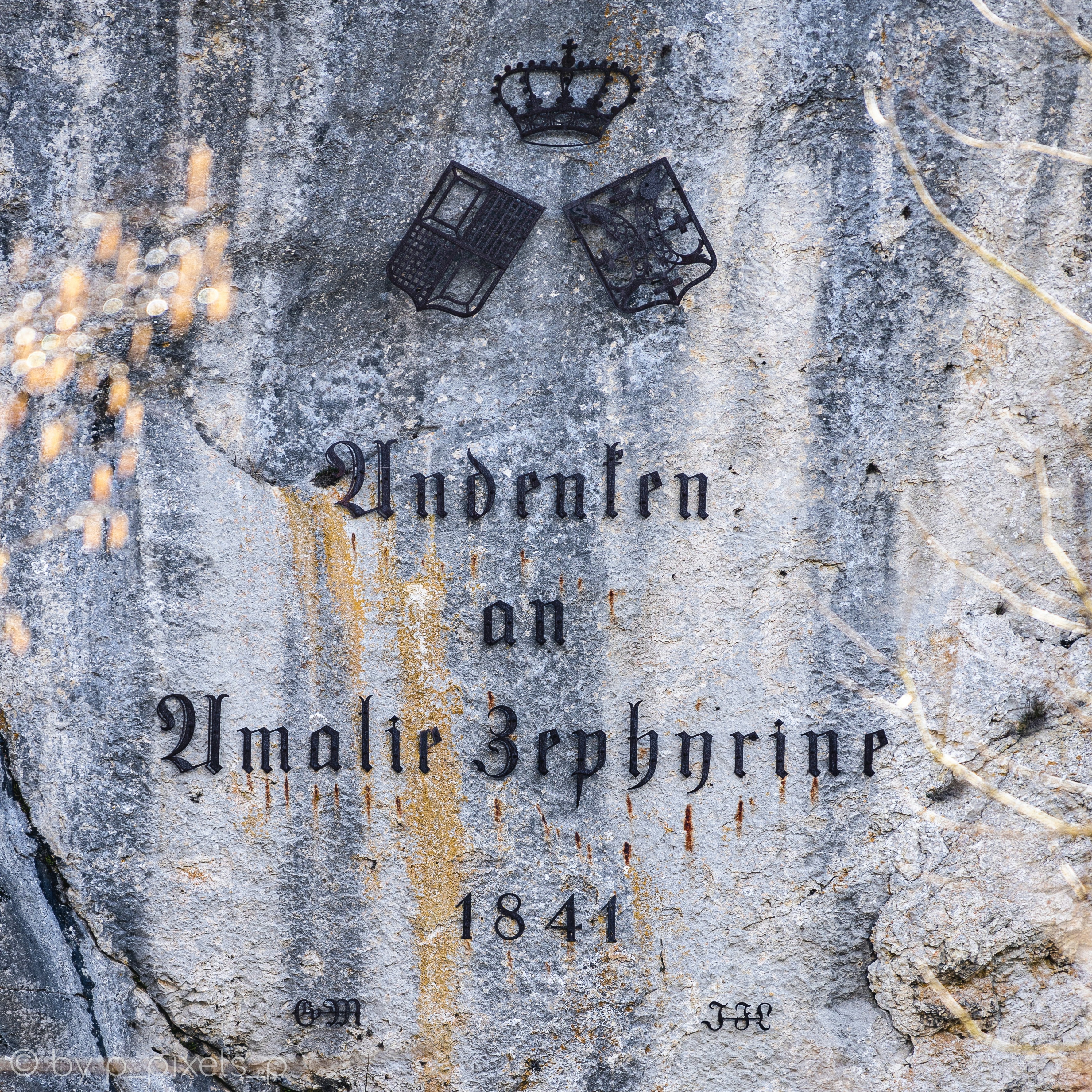 a sign on a rock with a crown on it
