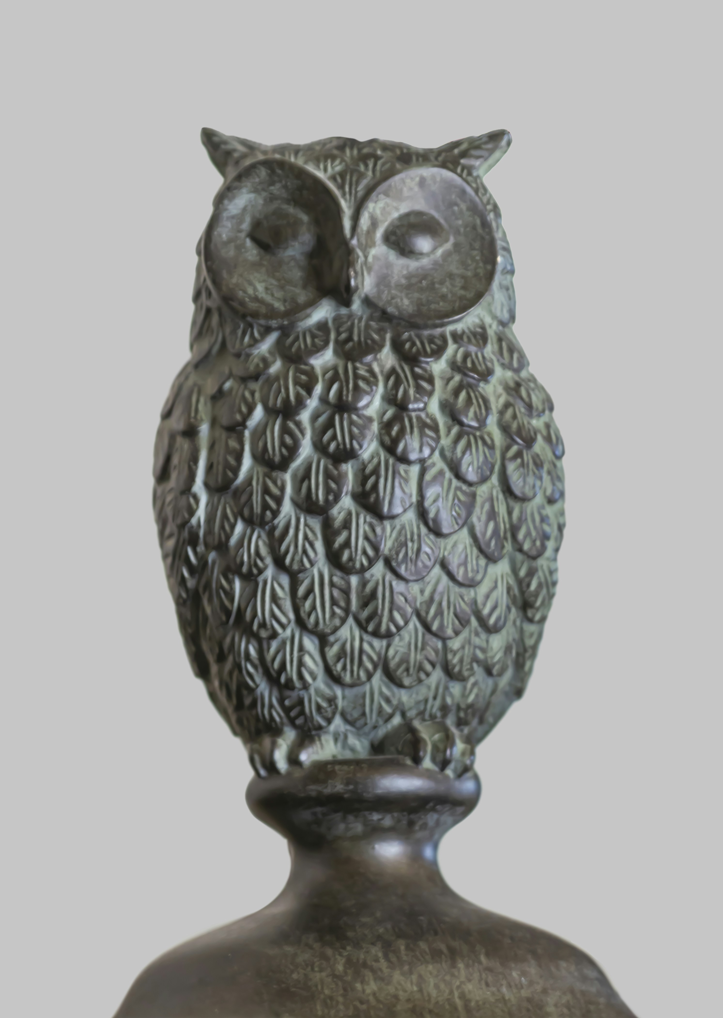 Bronze Sentinel: A Stoic Owl Guarding a Weathered Pedestal
