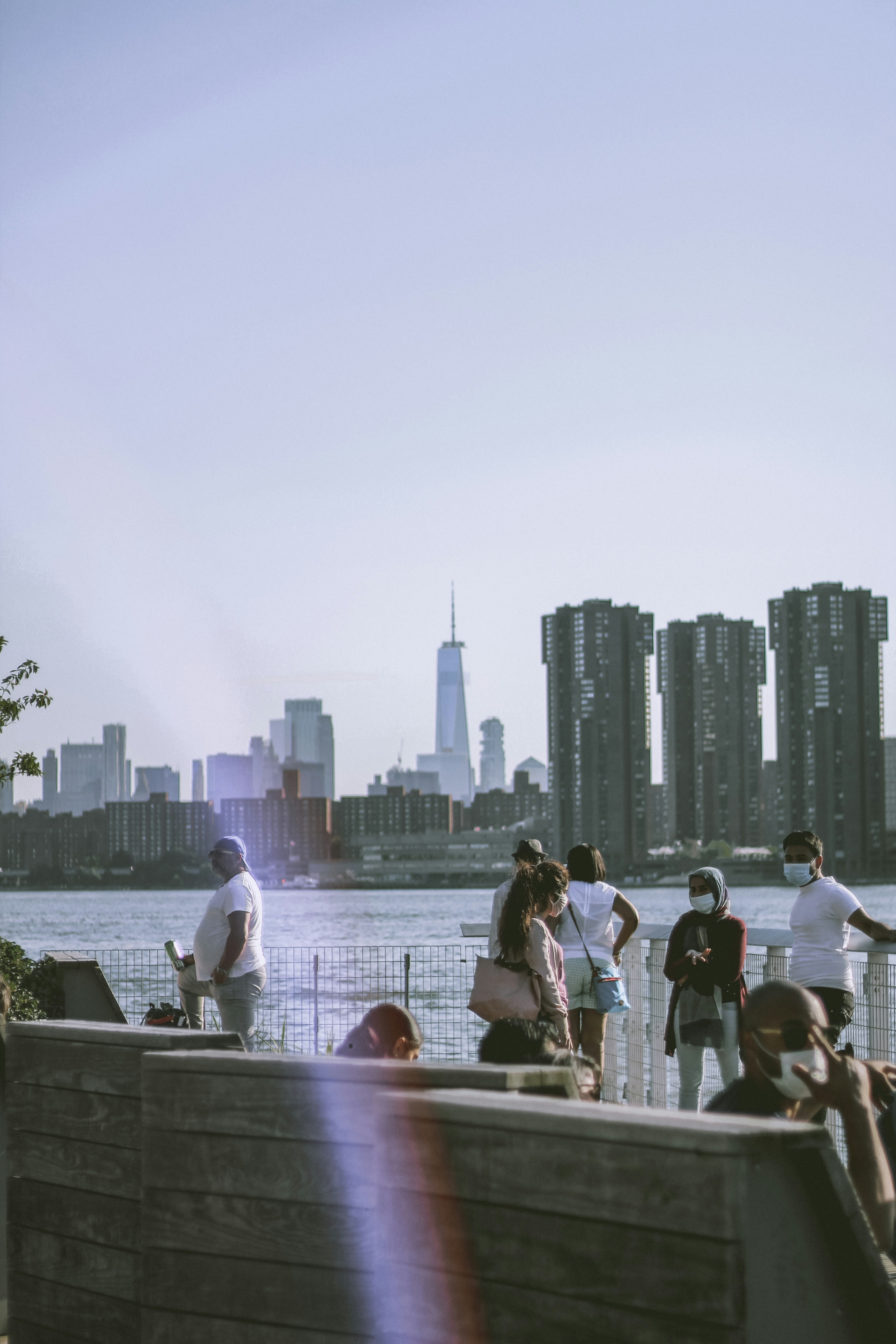 City by the River: Faces and Skyline Framed by a Transit of Light