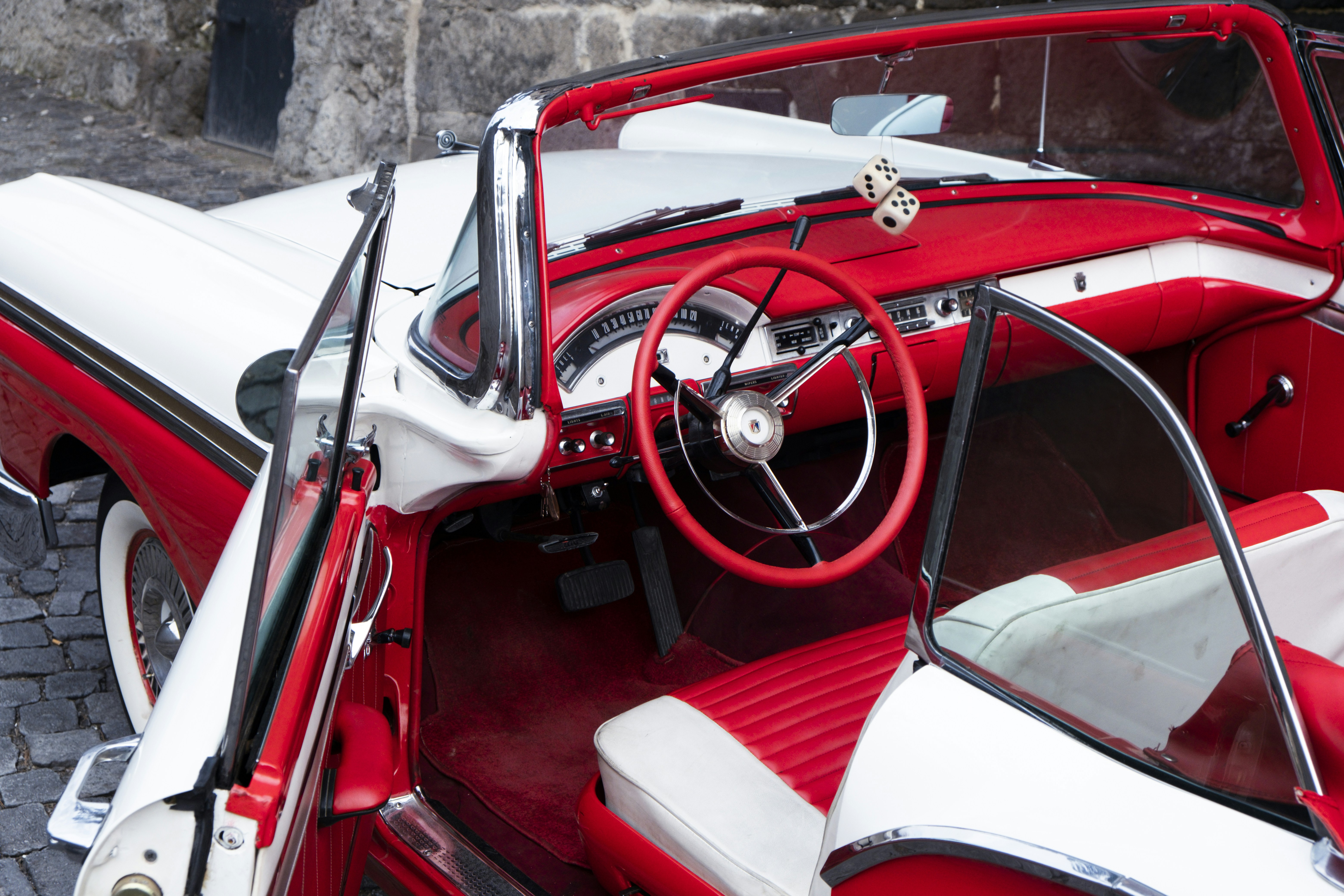Crimson Ivory Cockpit: A Vintage Convertible Meets Cobblestones