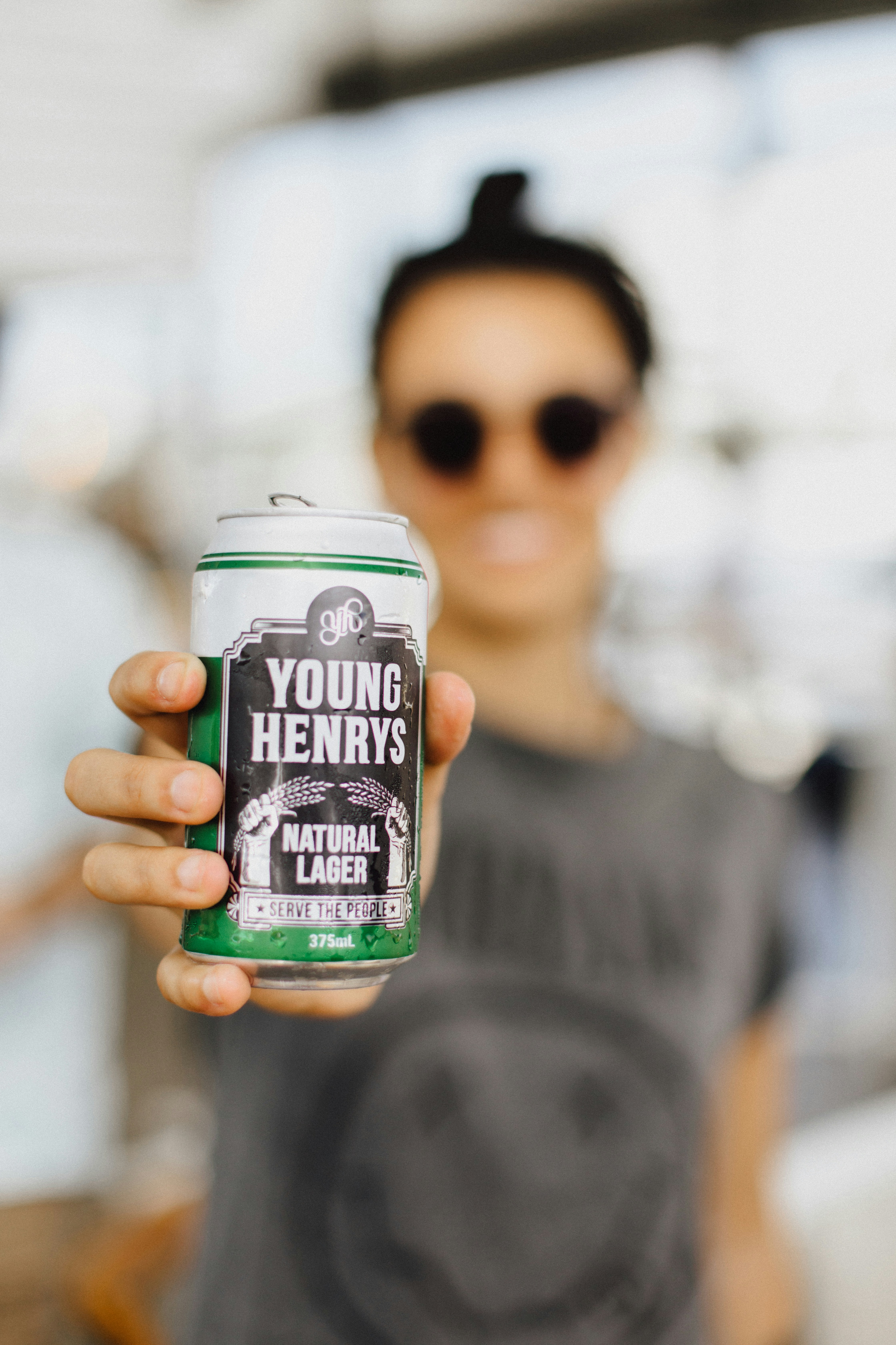 Can in Focus, Portrait in Soft Focus: A Close-Up of Young Henrys Against a Blurred Backdrop