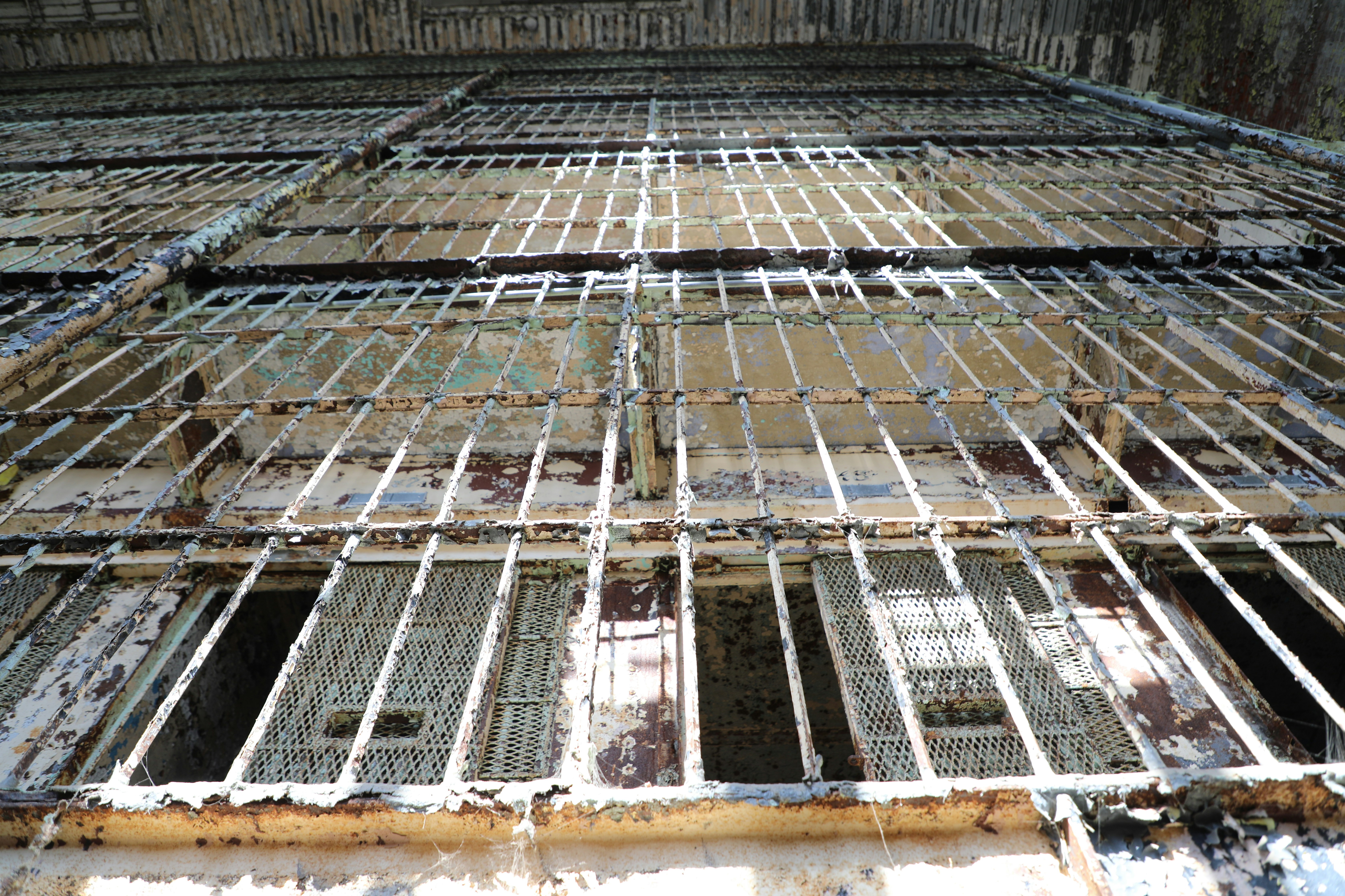 Weathered Lattice of Rust: A Decayed Window Grate