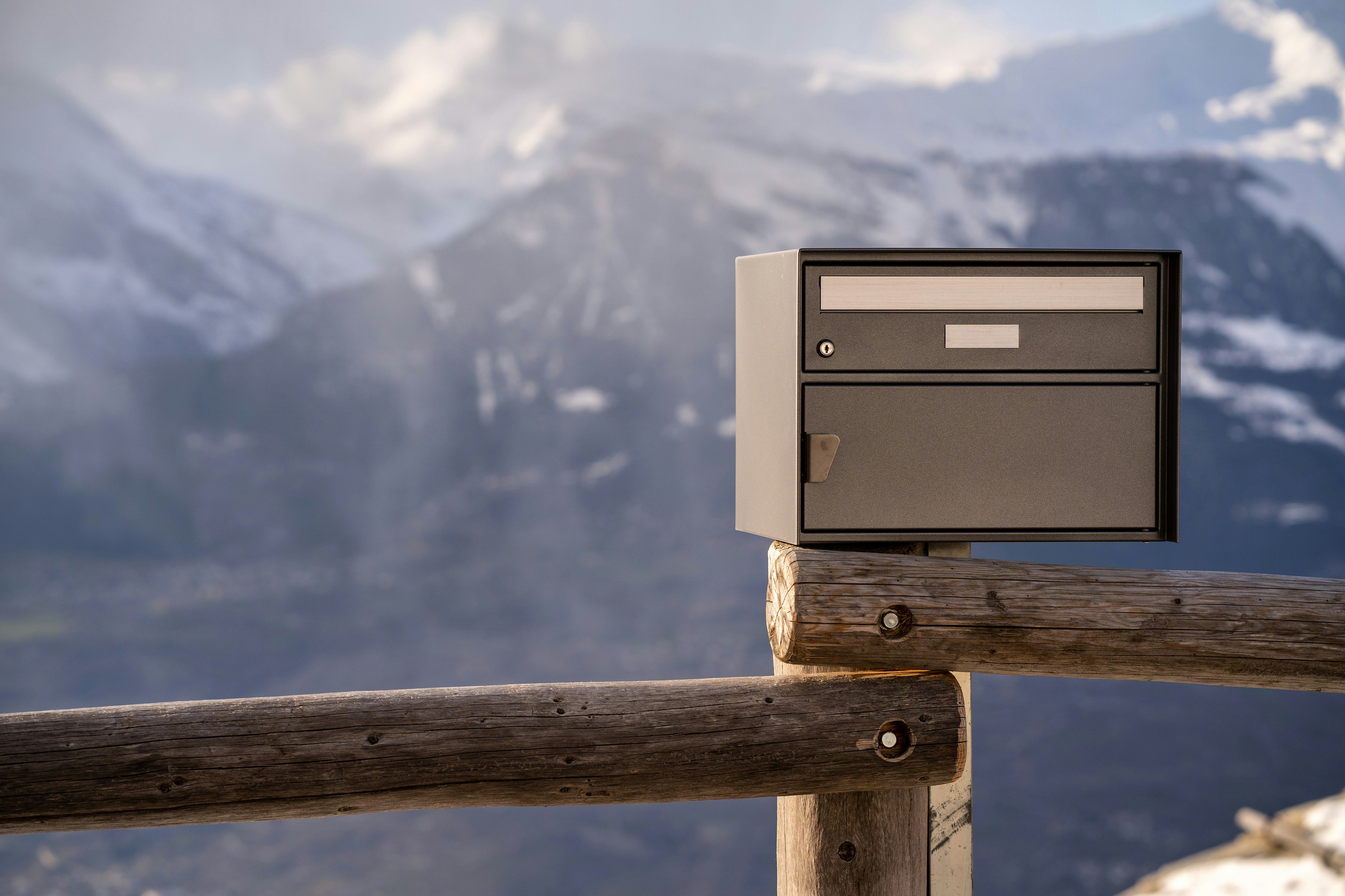 Lone Alpine Mailbox Overlooking a Snowbound Valley