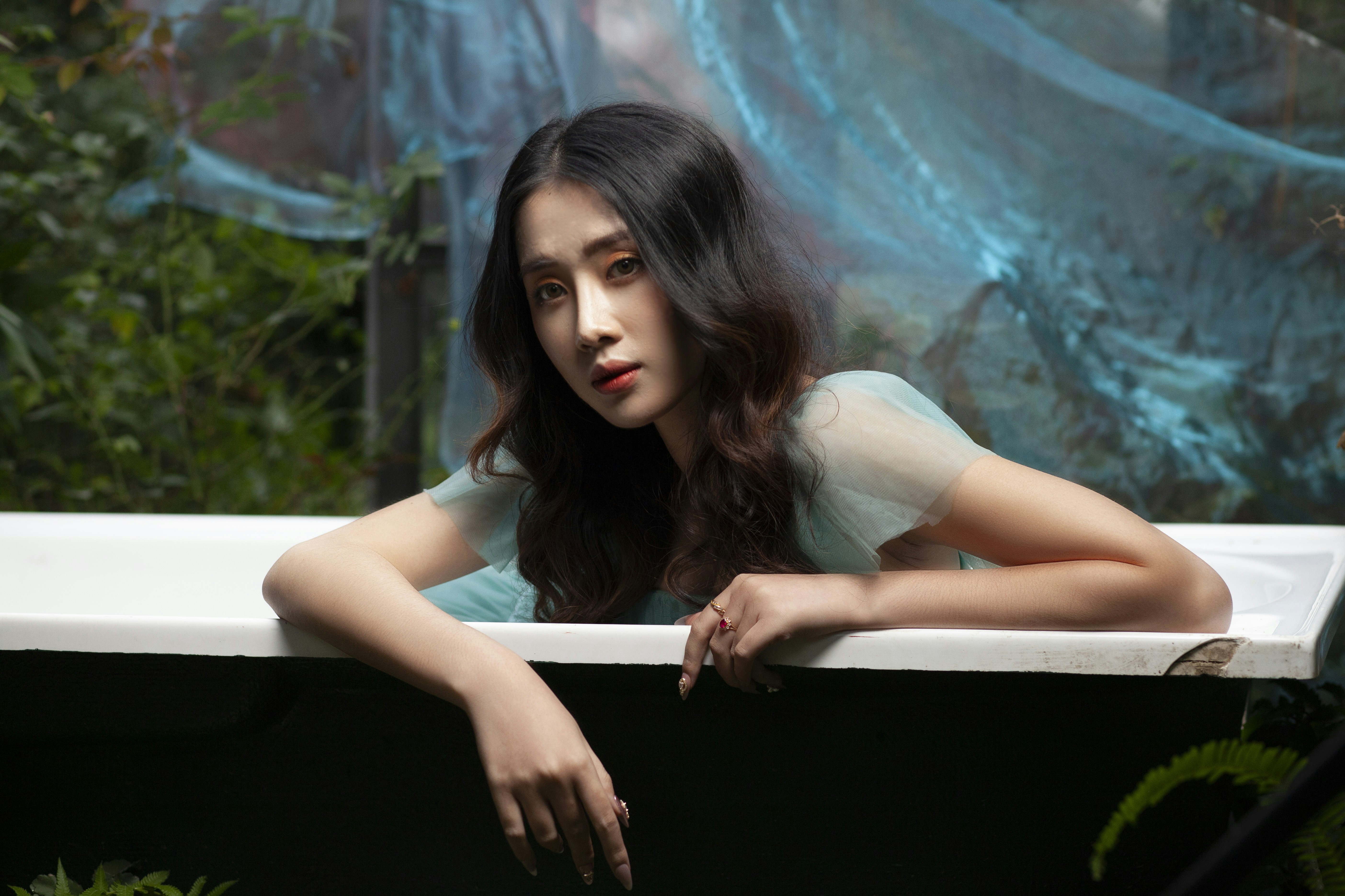 Woman in white tank top leaning on white wall photo – Free Studio Image ...