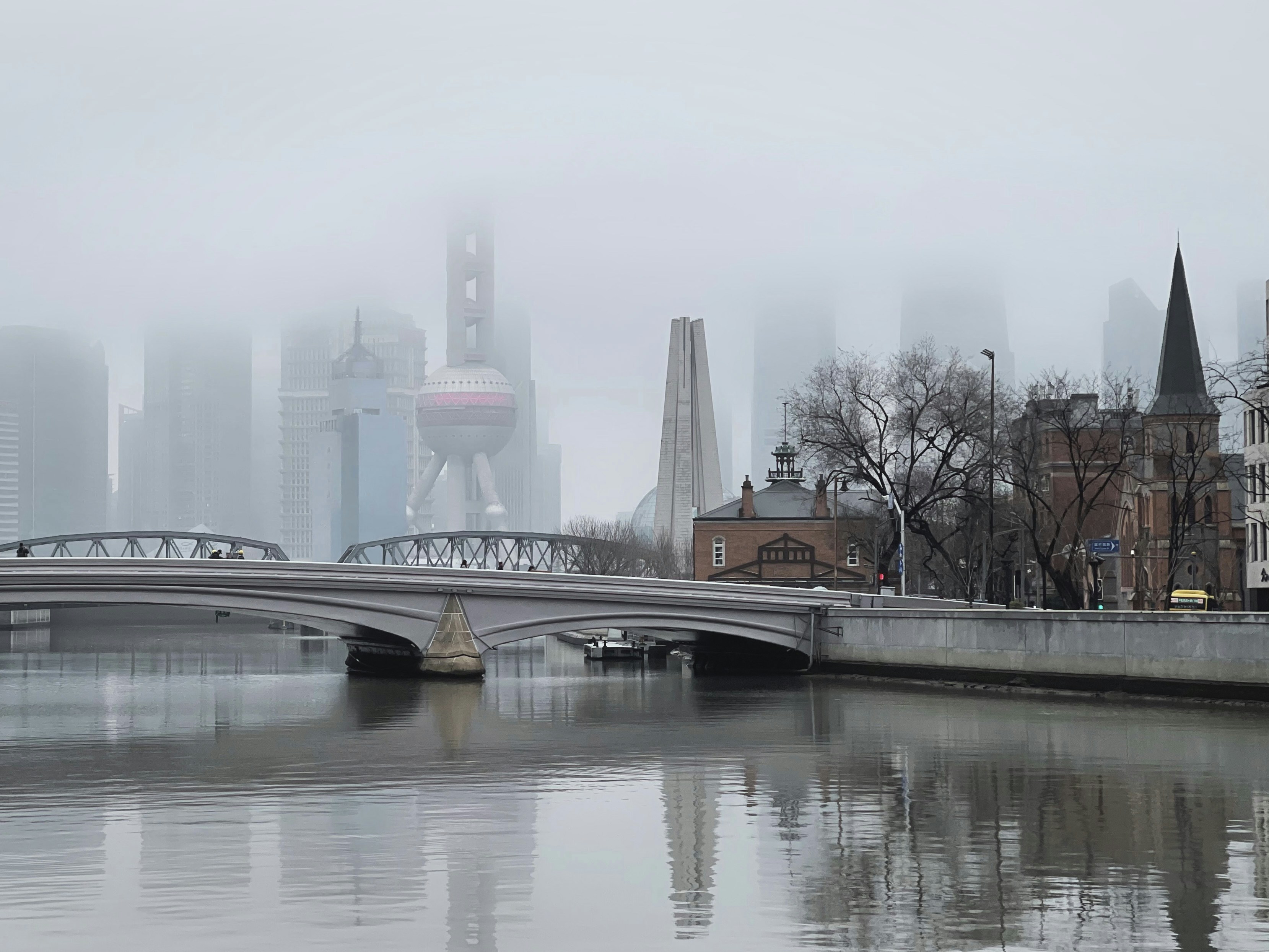 Misty River Crossing Under Silent Skyscrapers