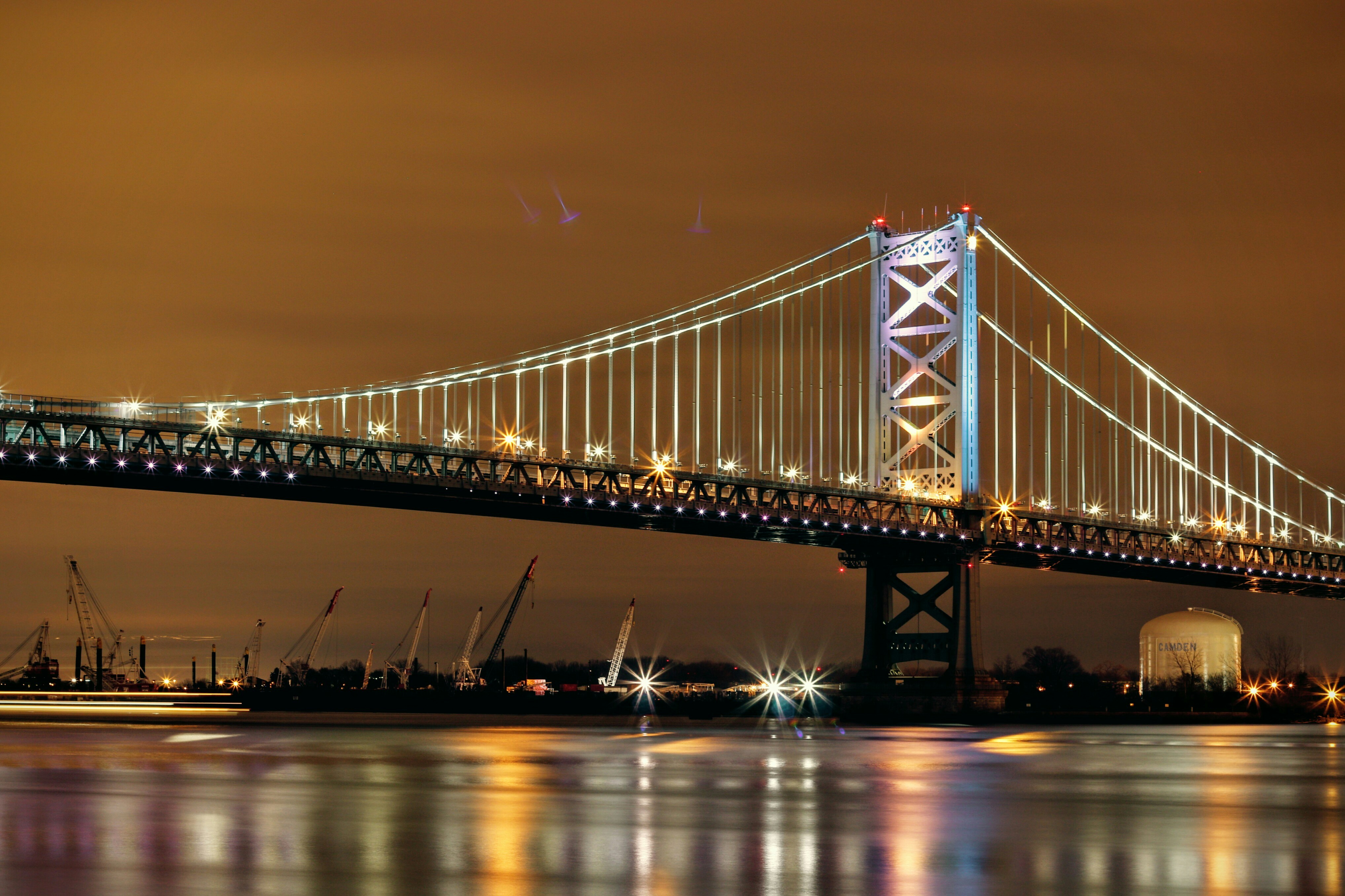 Amber Dusk Suspension Bridge Over Quiet Waters