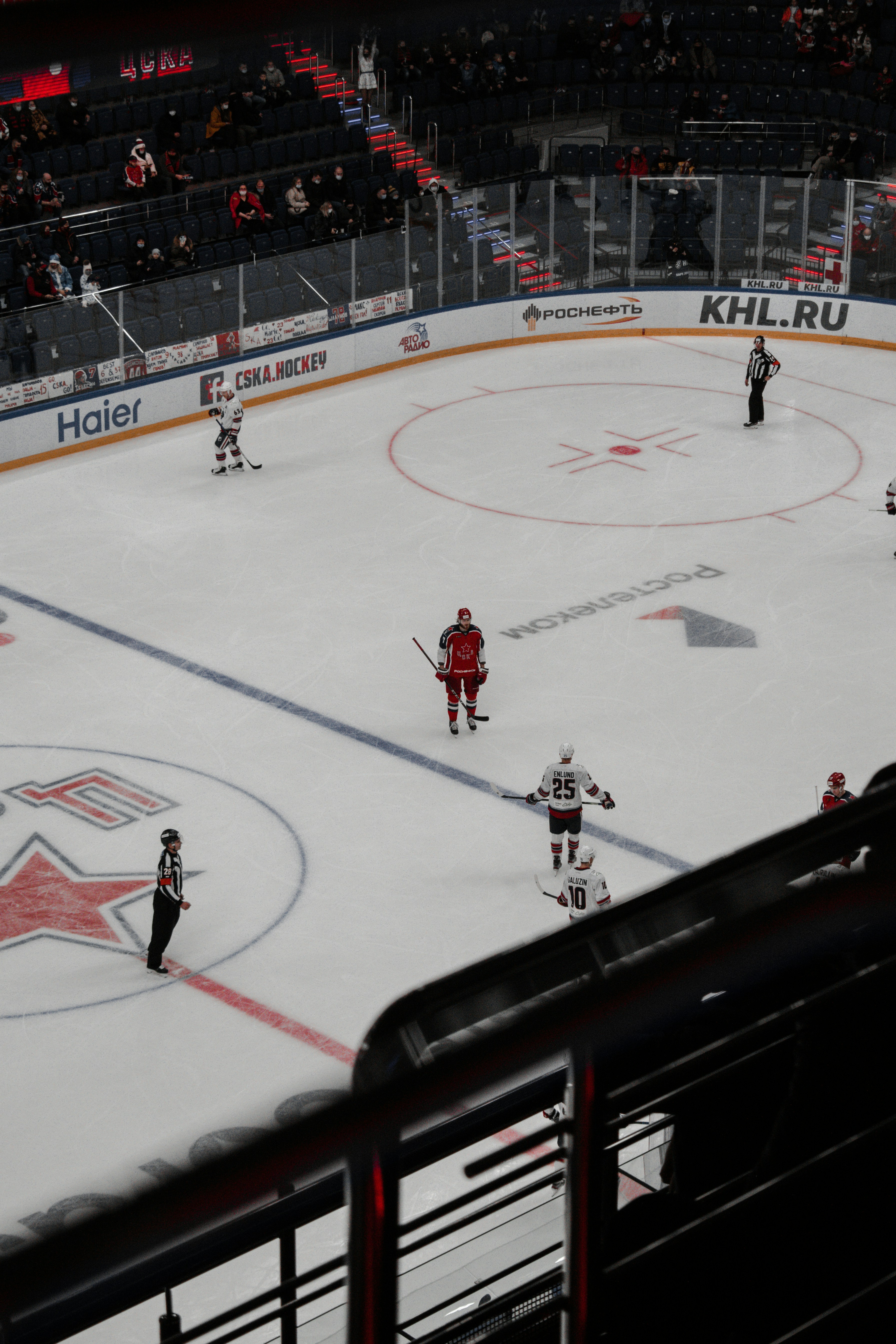 Center Ice Stillness: Red Jersey Stands Alone on a Quiet Rink