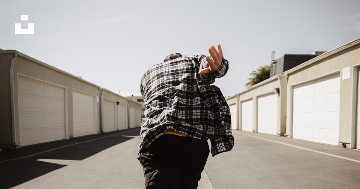 Man In Black And White Plaid Dress Shirt And Black Pants Standing On