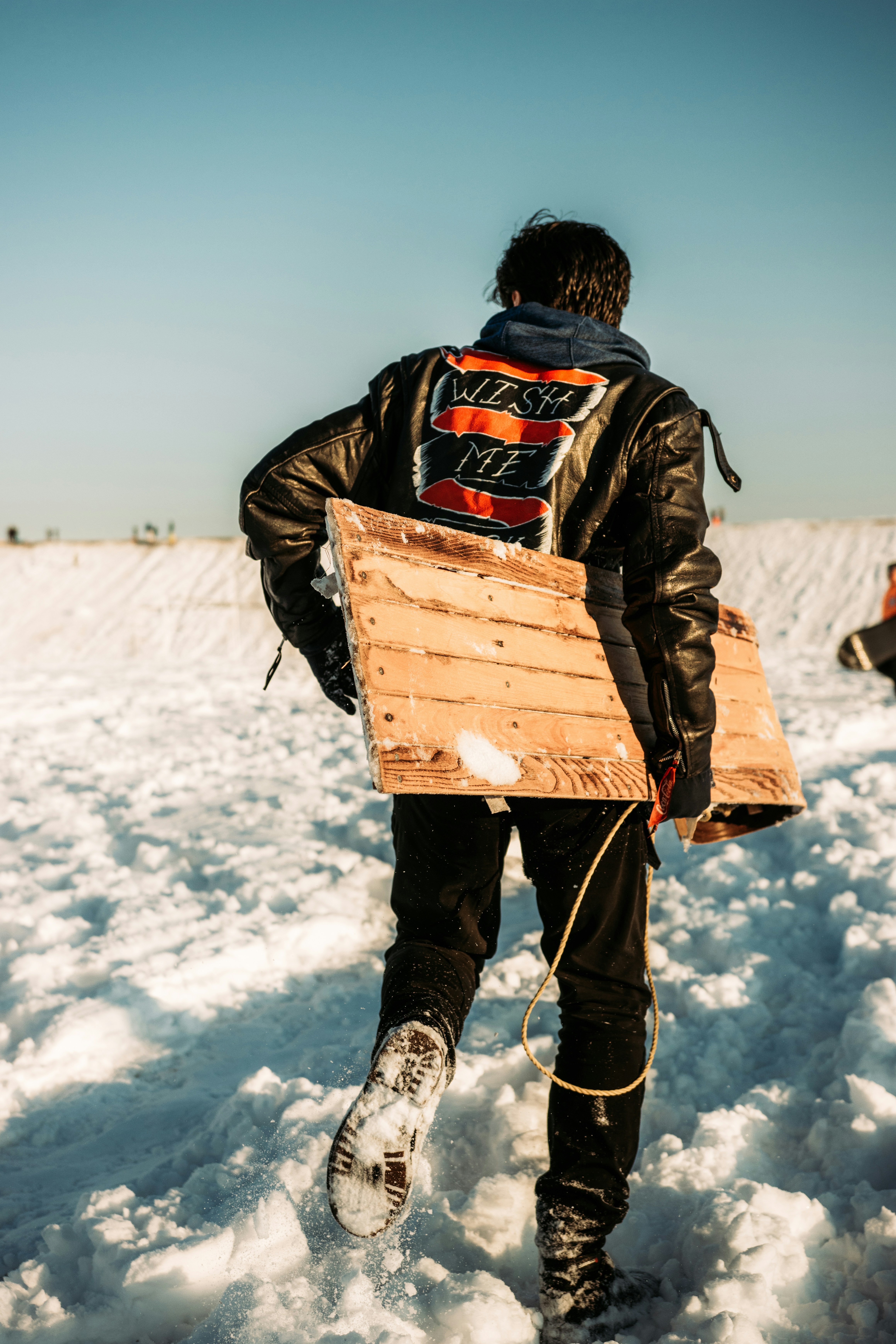 Snowbound Climber Carrying a Wooden Shield Through Powder