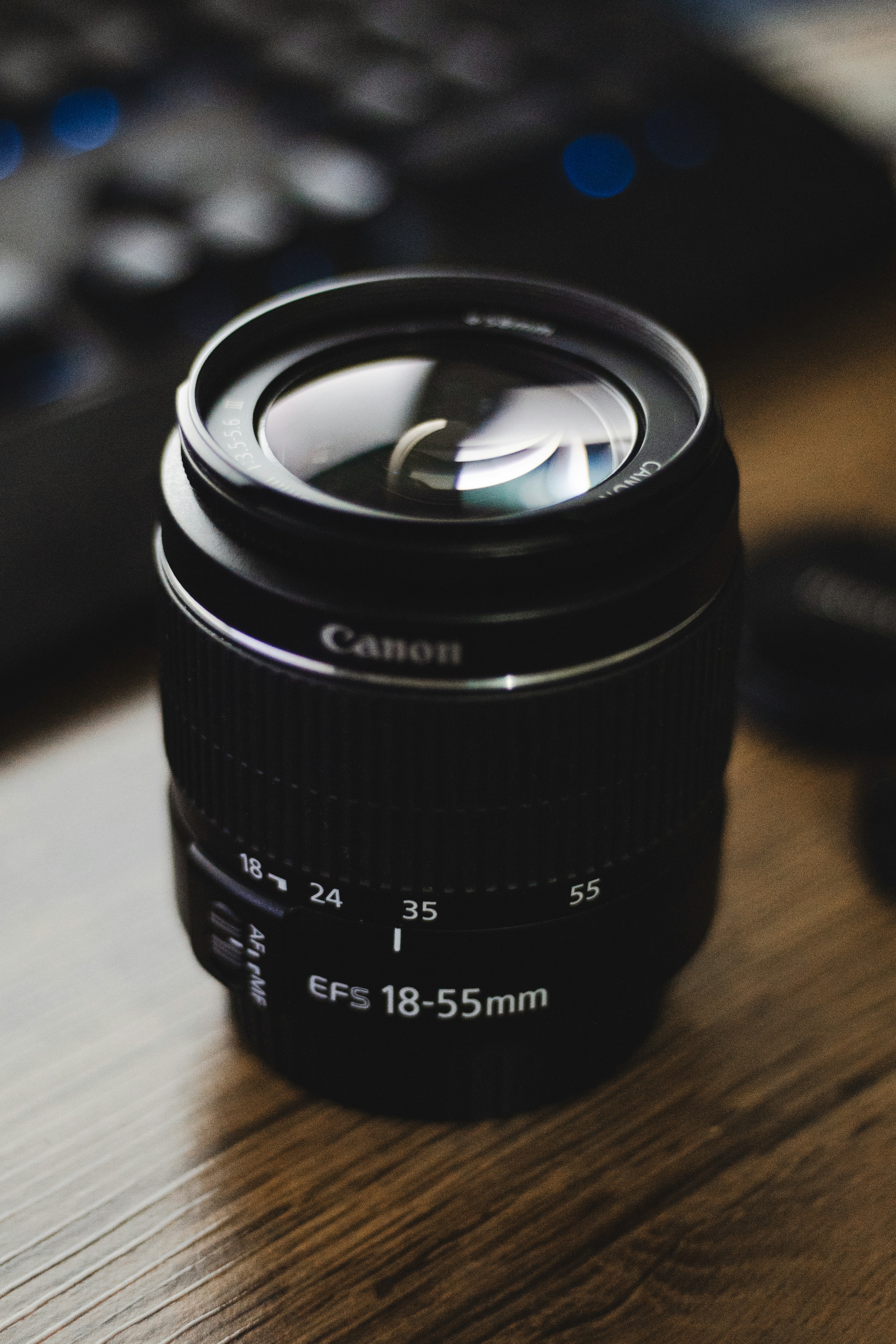 Black camera lens on brown wooden table photo – Free Camera lens Image ...