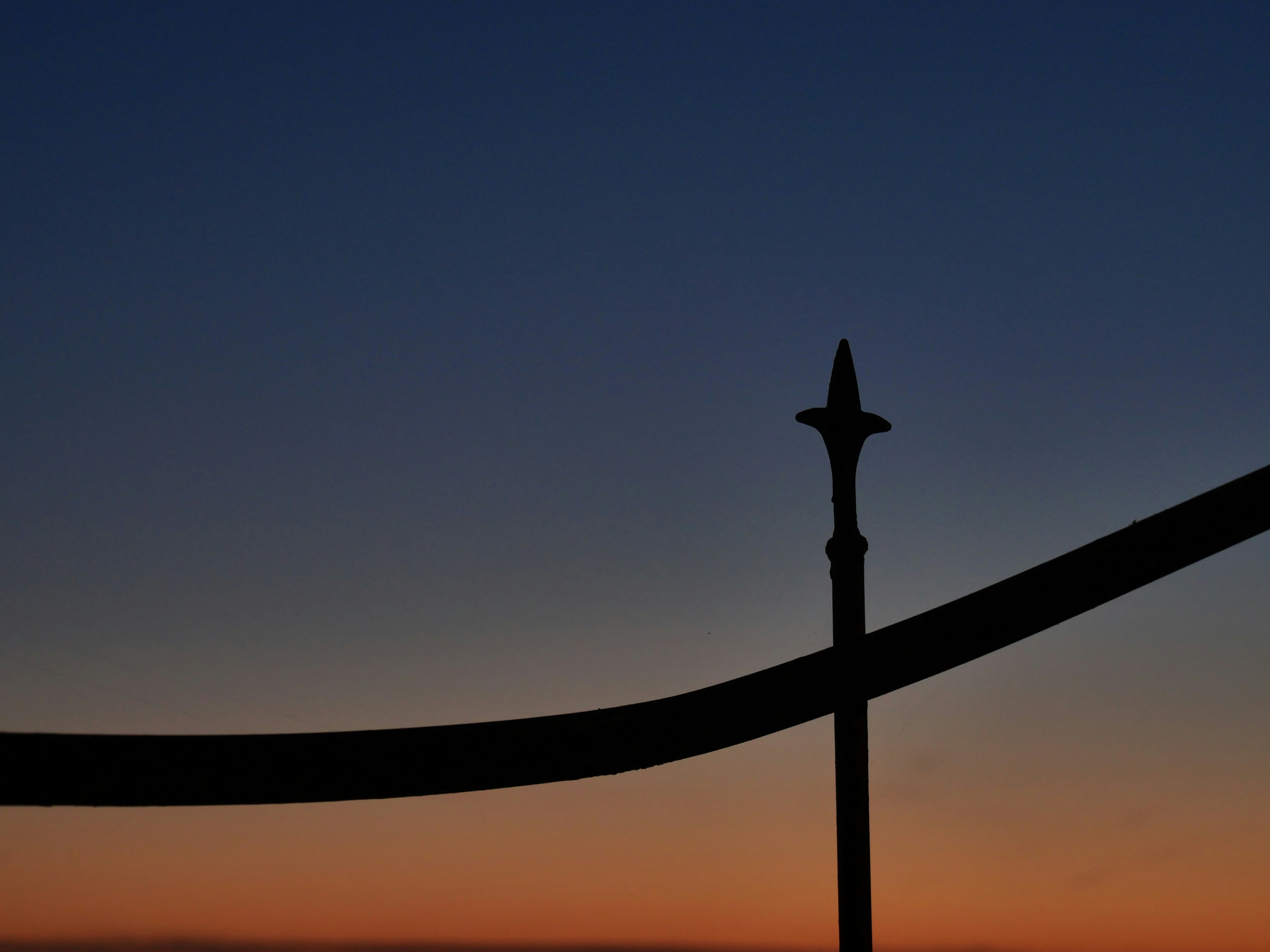 Spear-Topped Curve: Dusk Silhouette Across a Quiet Horizon