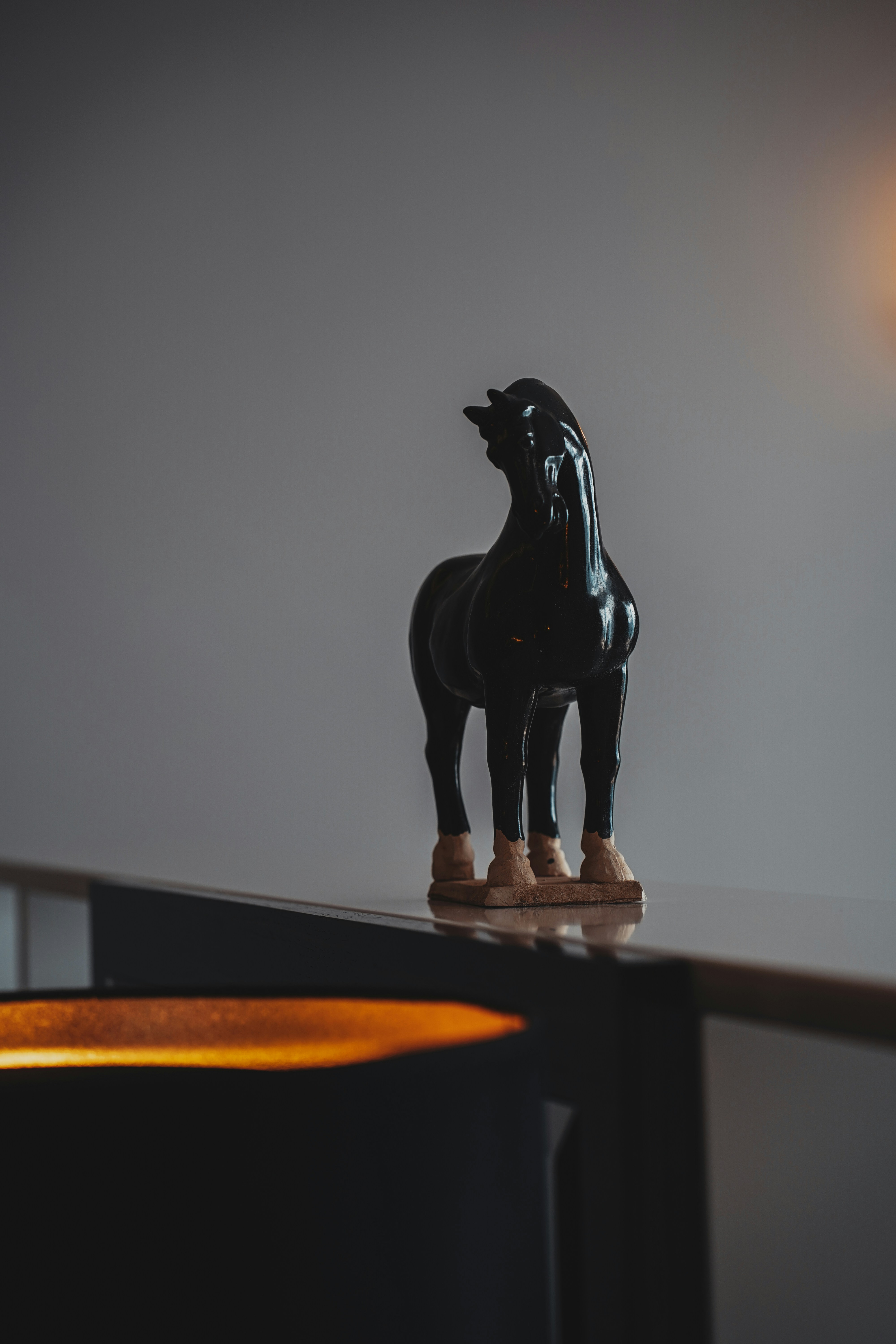 black horse figurine on brown wooden table