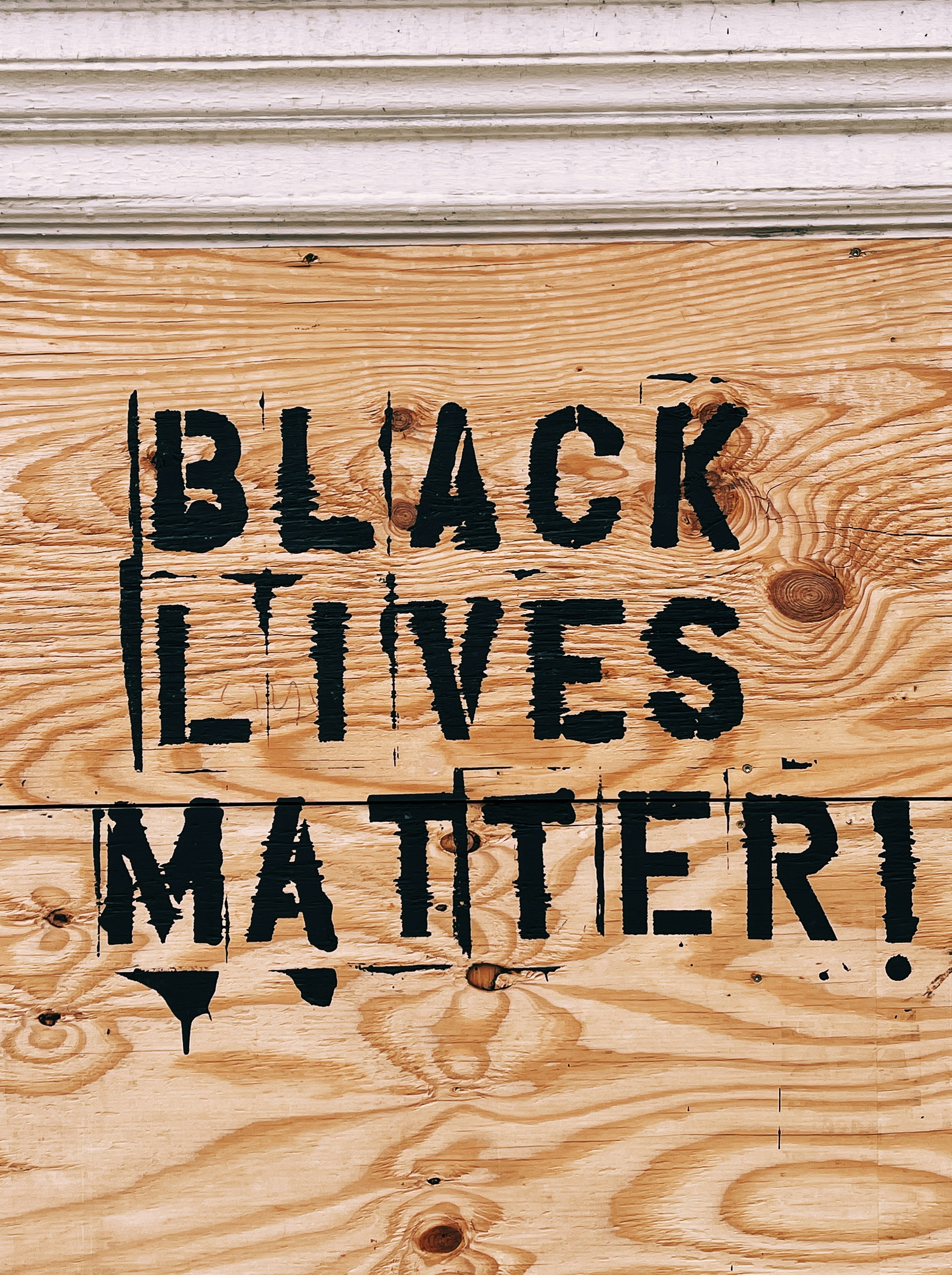 a wooden sign that says black lives matter
