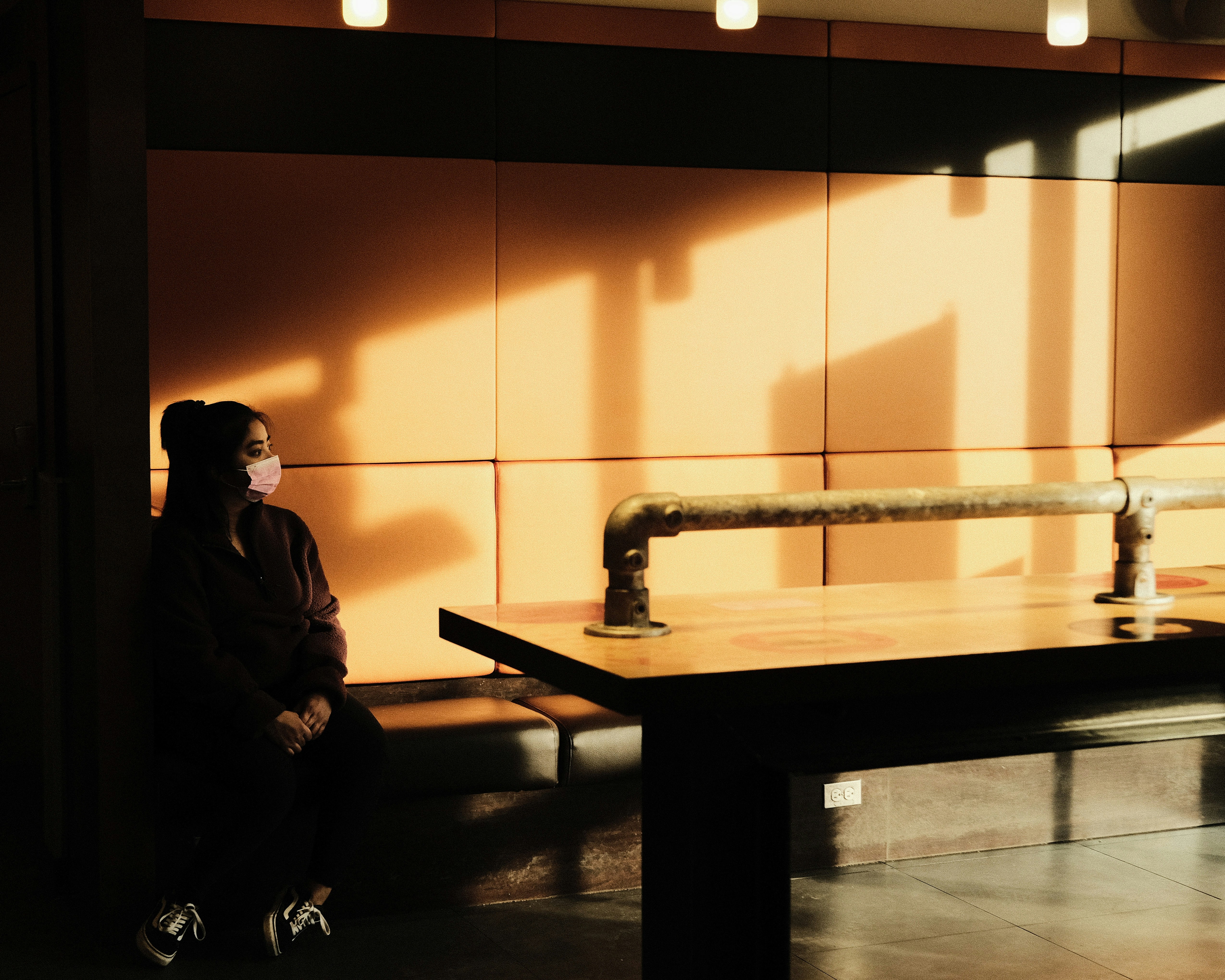 Warm Silence: Sunlit Figure in a Modern Lobby