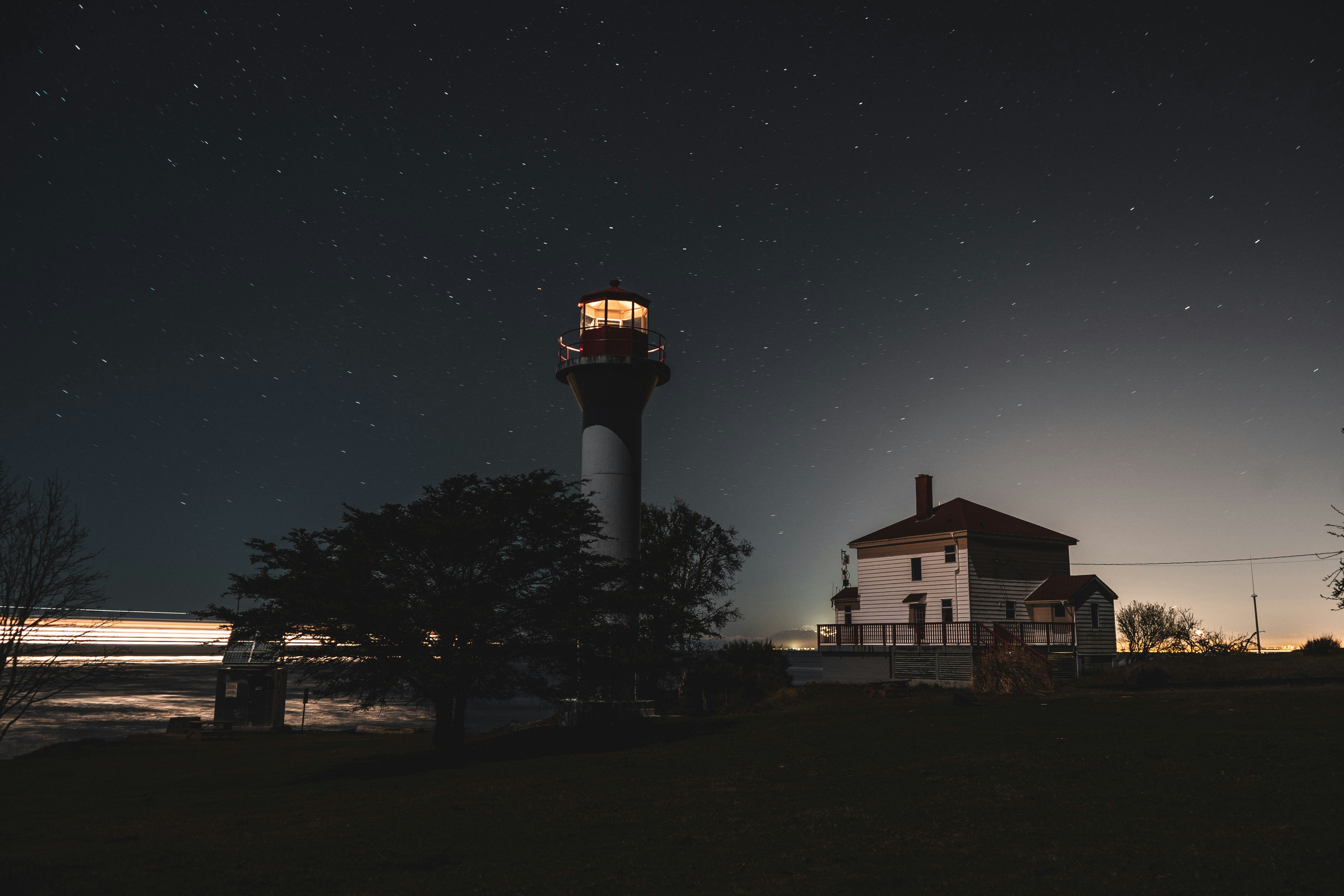 Starbound Beacon: A Lone Lighthouse Under a Star-Strewn Night