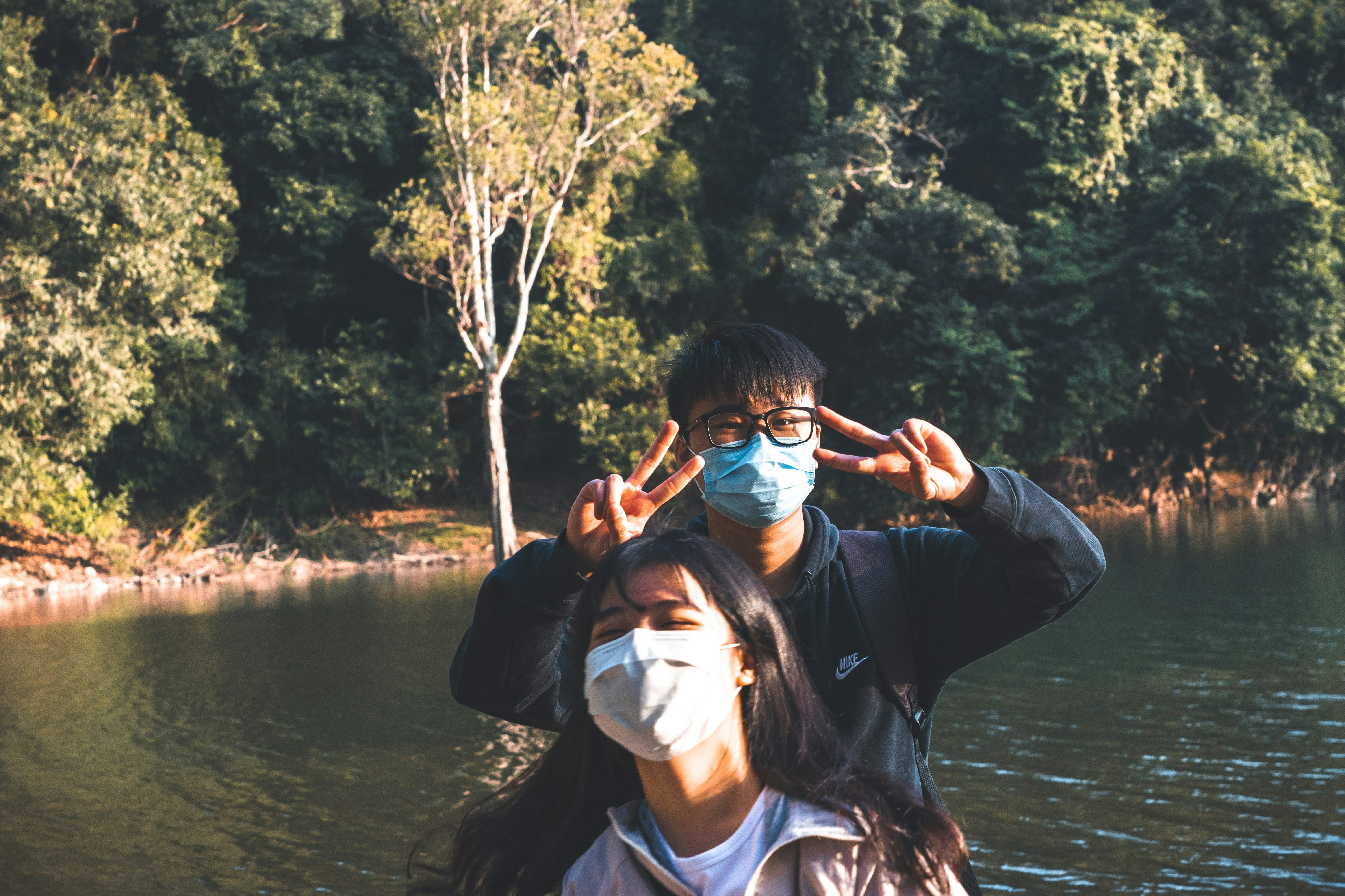 Lakeside Laughter: Masks, Light, and a Friendly Pose