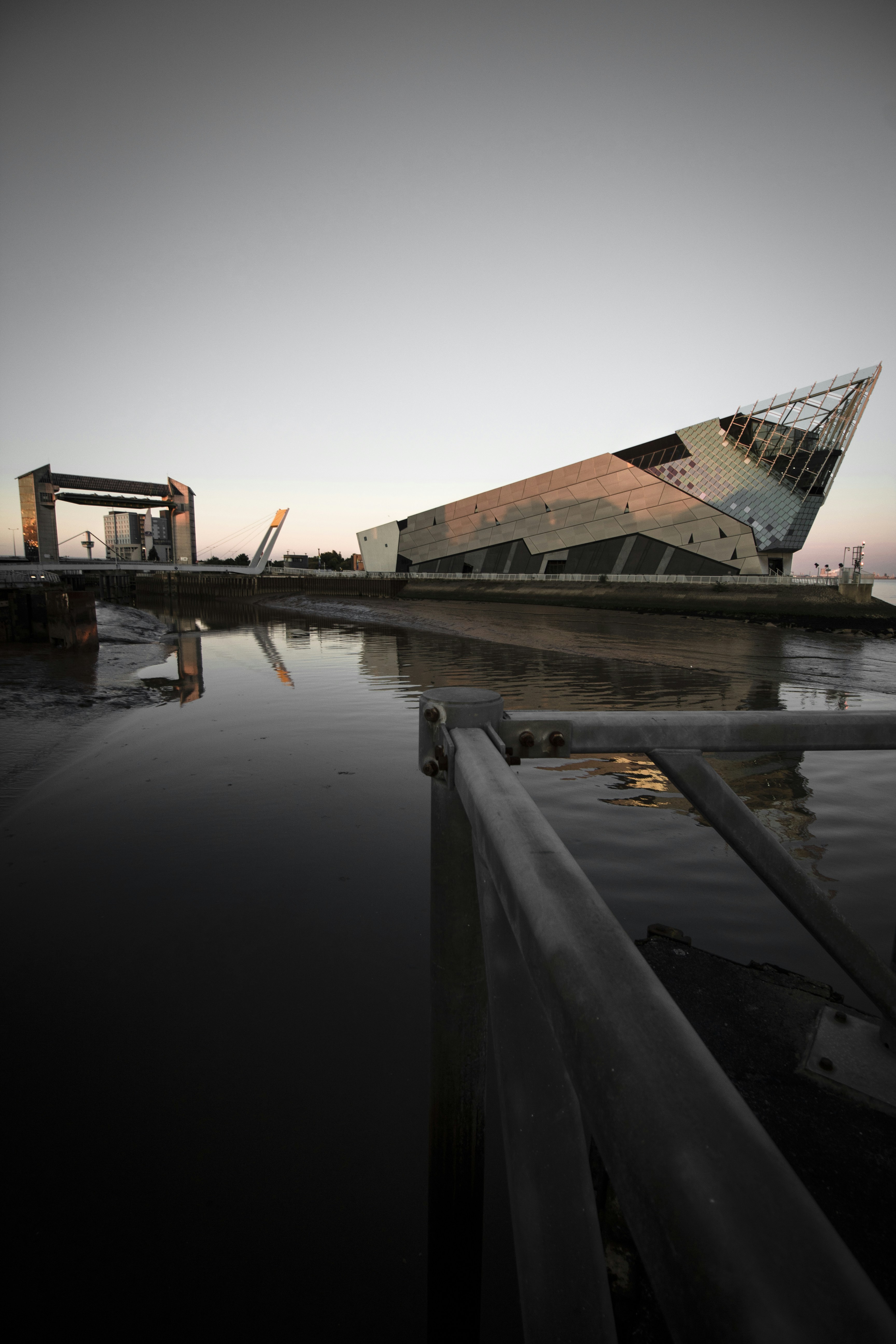 brown and white concrete building beside body of water during daytime