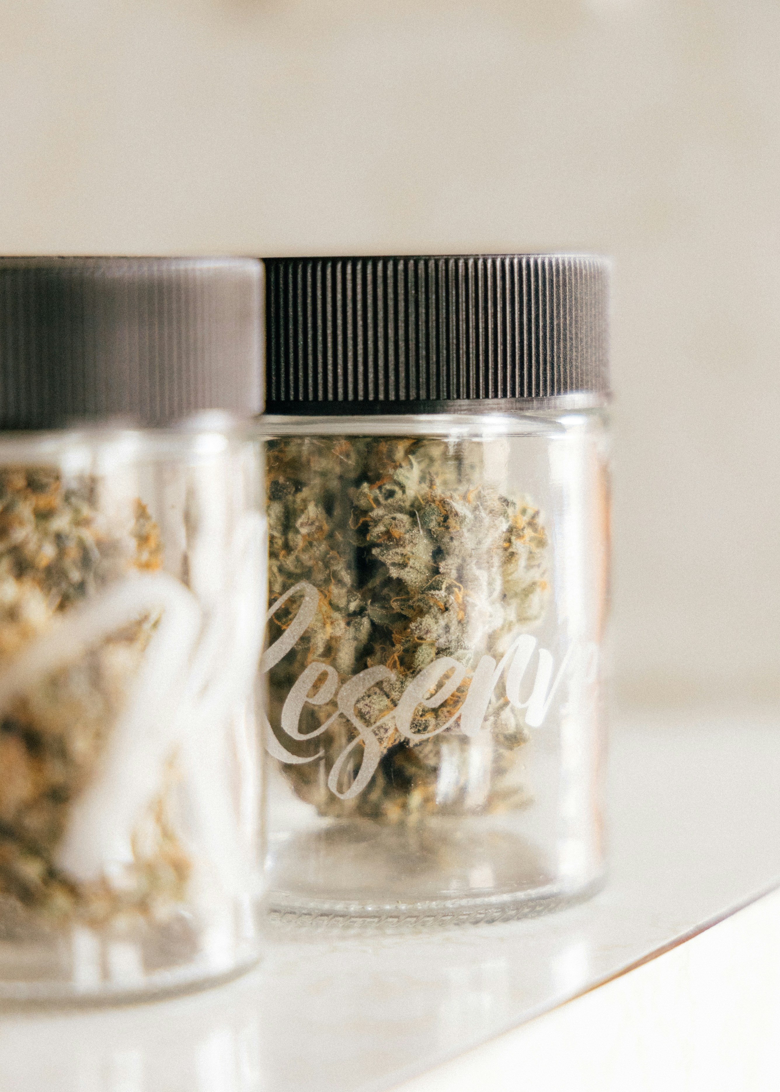 Centered in Glass: Close-Up of Cannabis Buds in Clear Jars