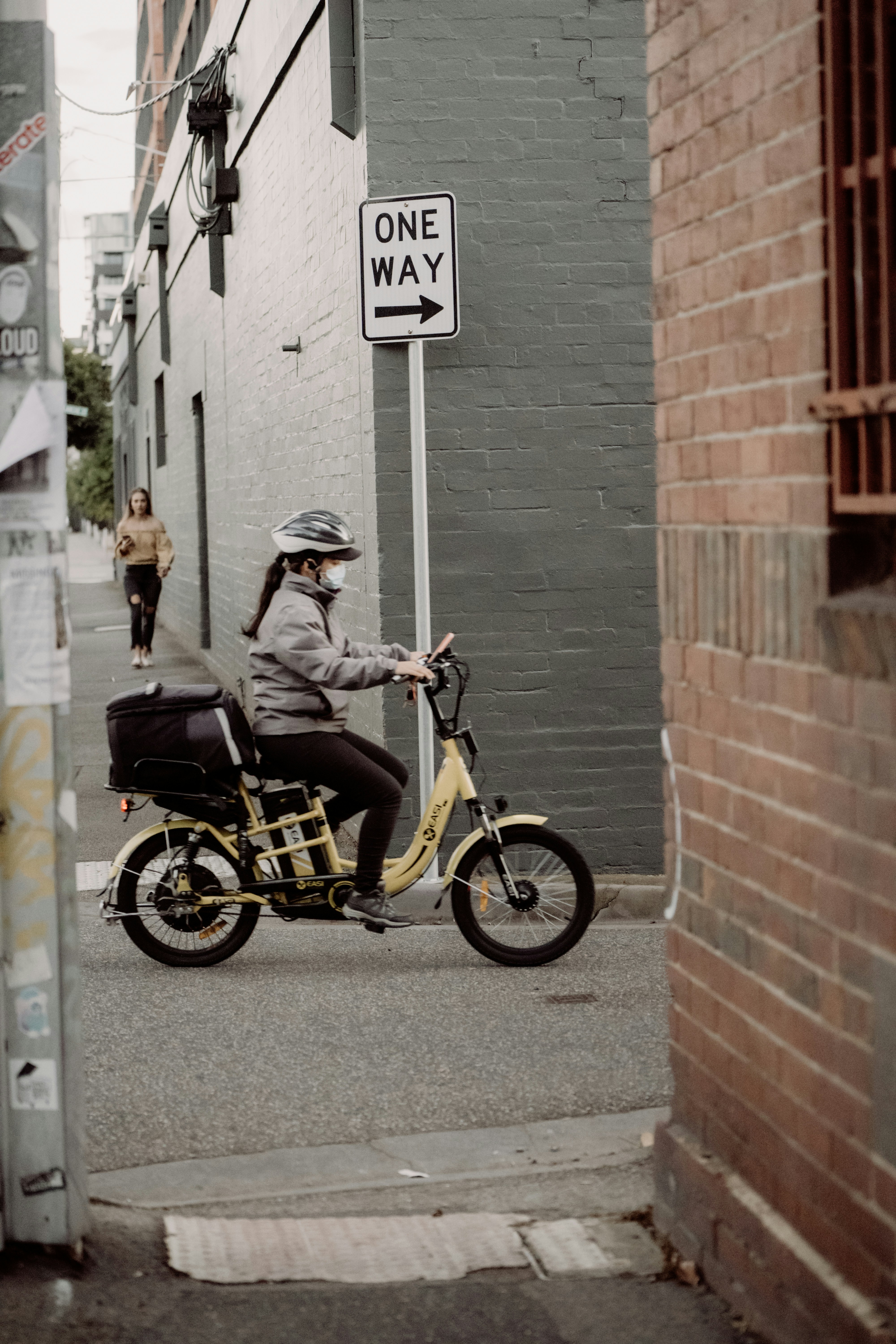 Pause on a Yellow E-Bike in a Narrow City Alley