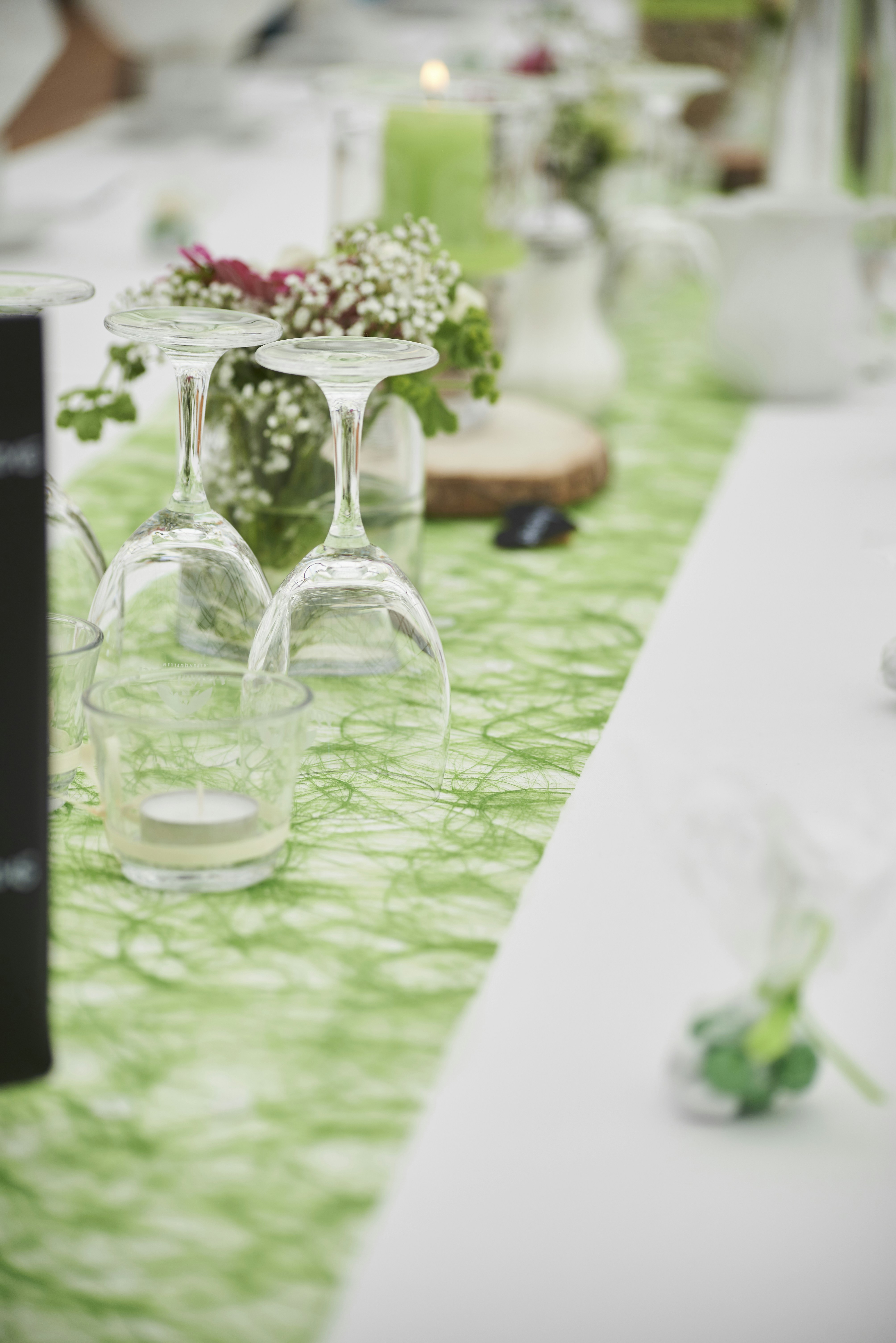 Glassware on a Green-Accent Table Setting with Floral Centerpieces