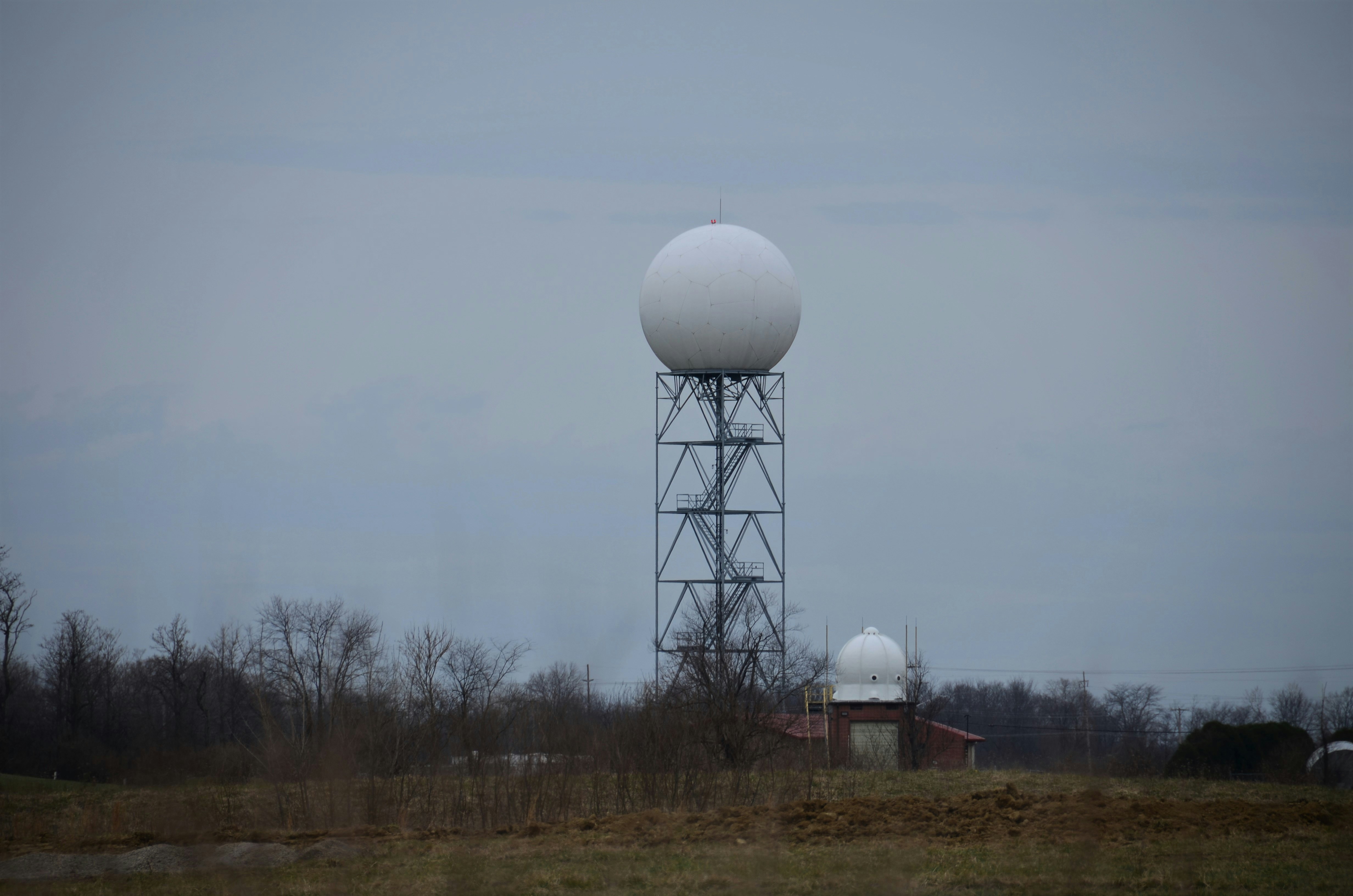 Radome Sentinel: A White Sphere Crowned atop a Steel Lattice Tower