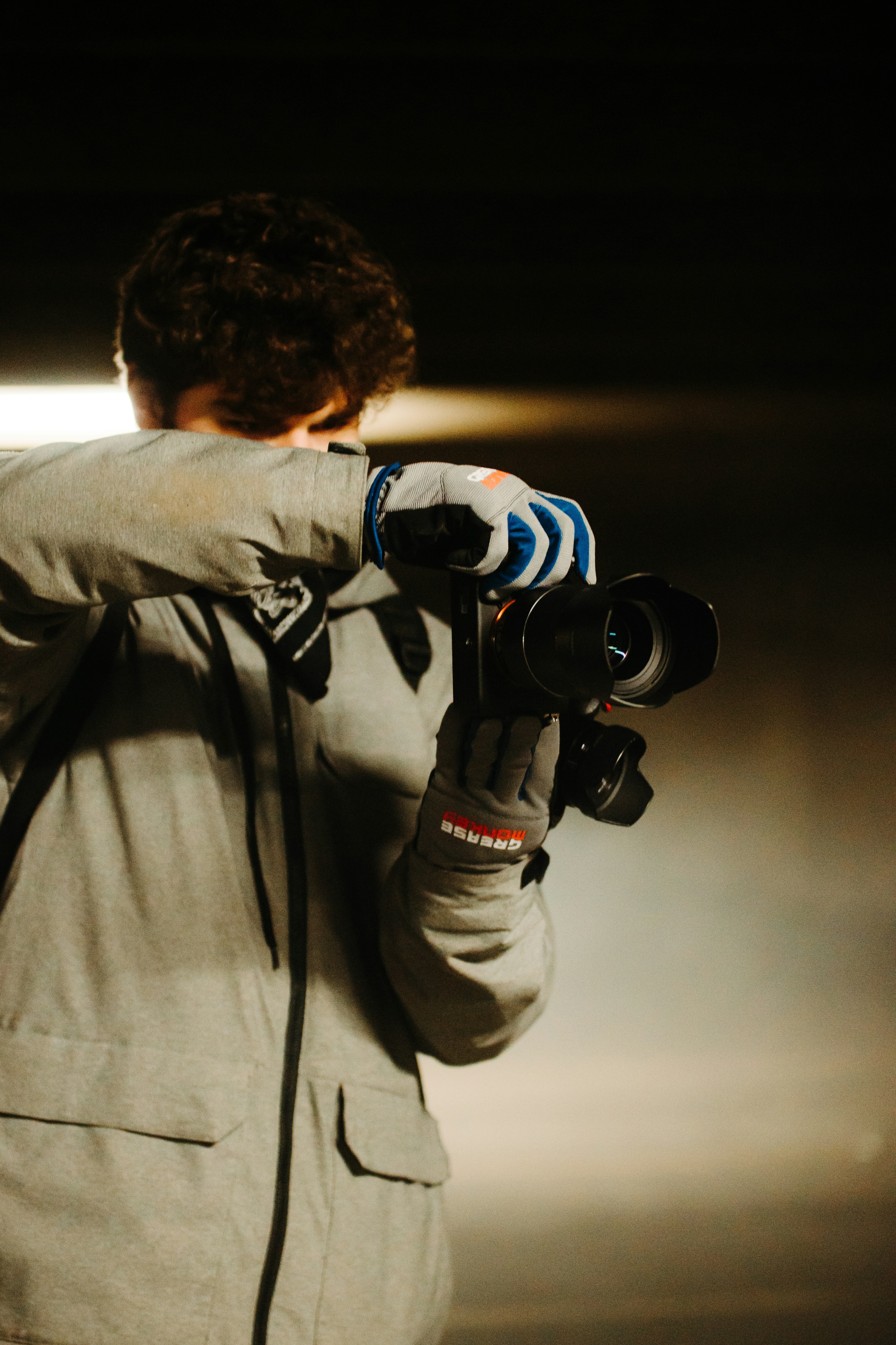 Man in gray jacket holding black dslr camera photo – Free Human Image ...