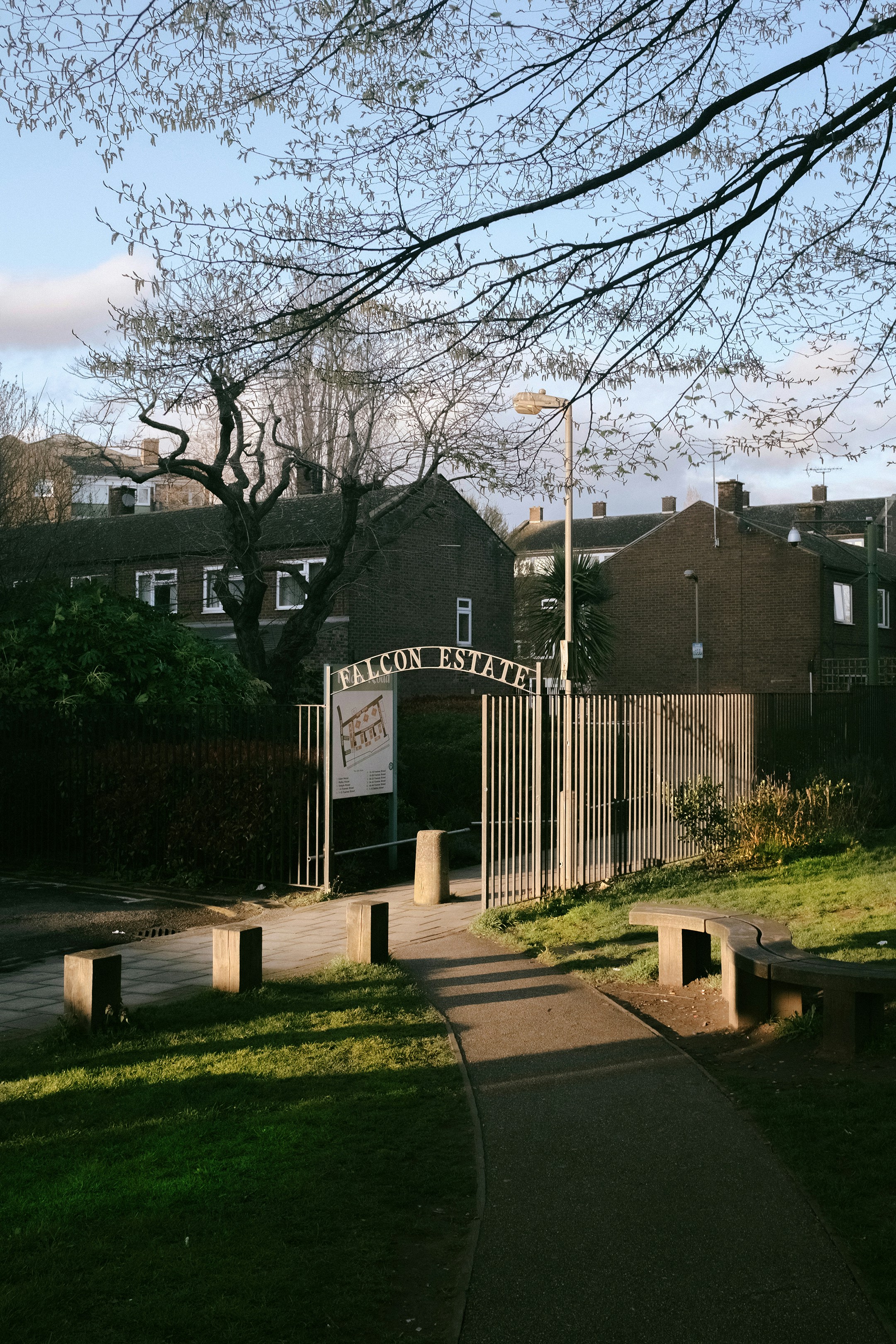 Iron Gate into the Elm Court: A Quiet Park Path at Dusk
